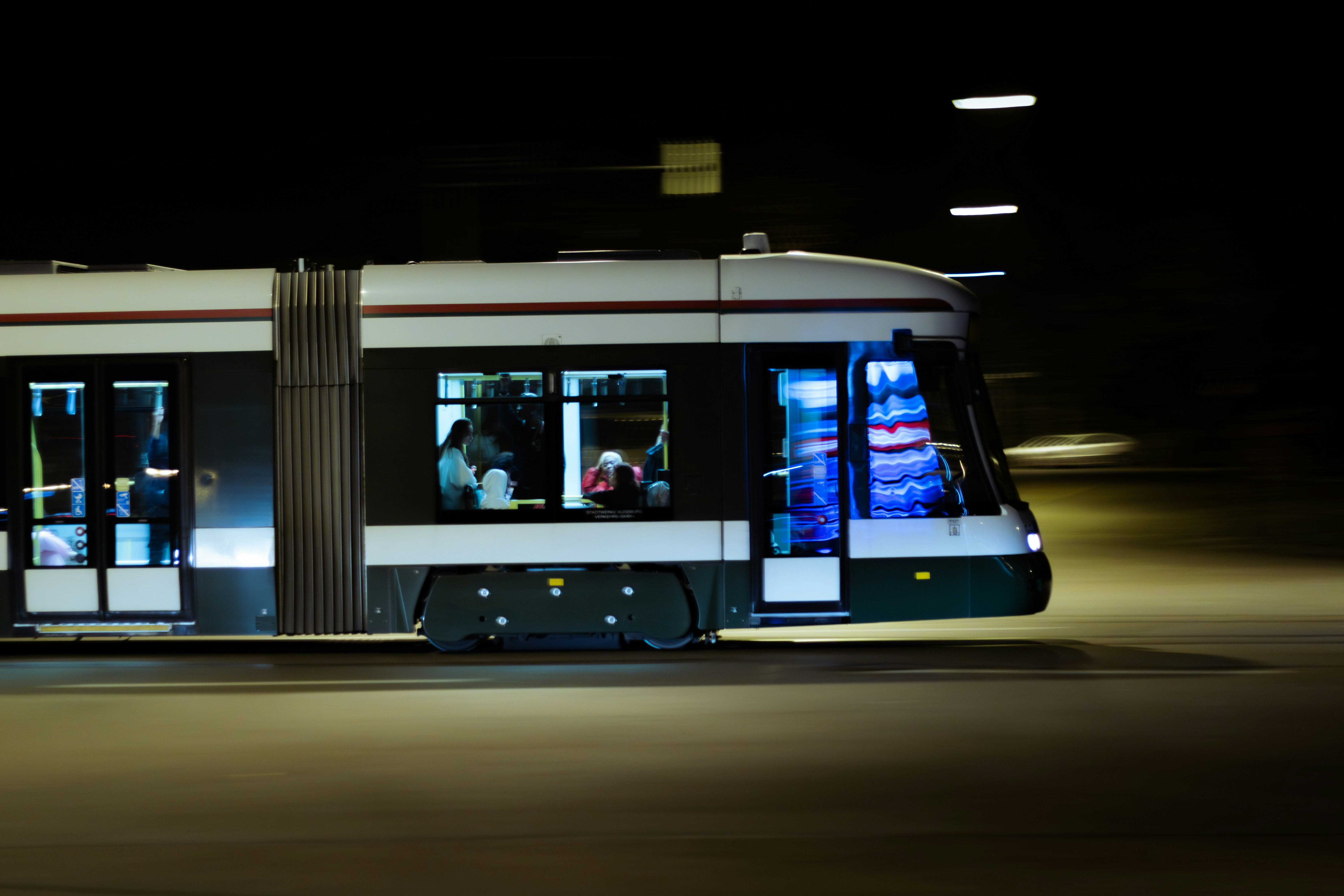 A train traveling down train tracks at night