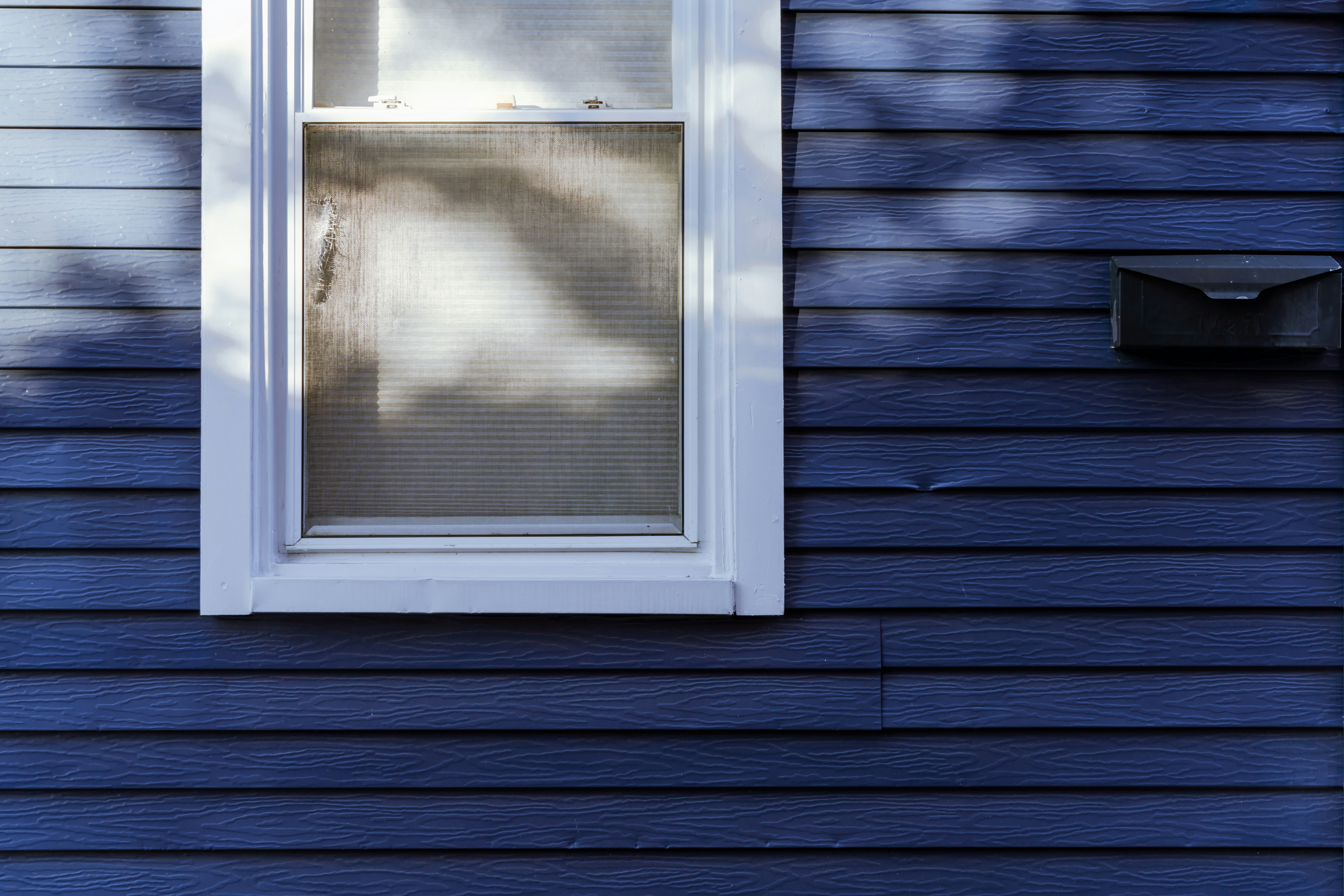 A blue house with a white window and blue siding photo – Free ...