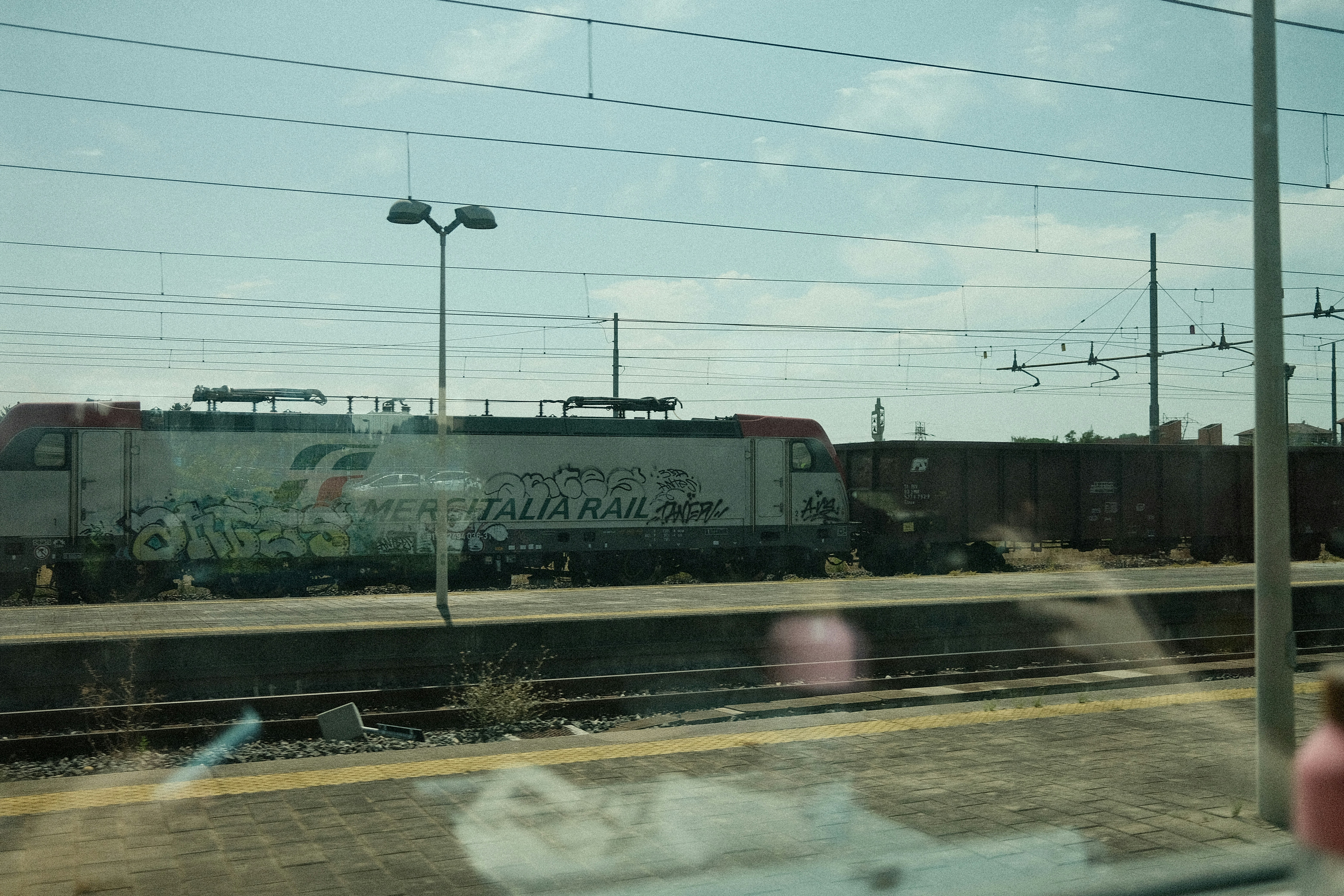 A train traveling down train tracks next to a train station photo ...