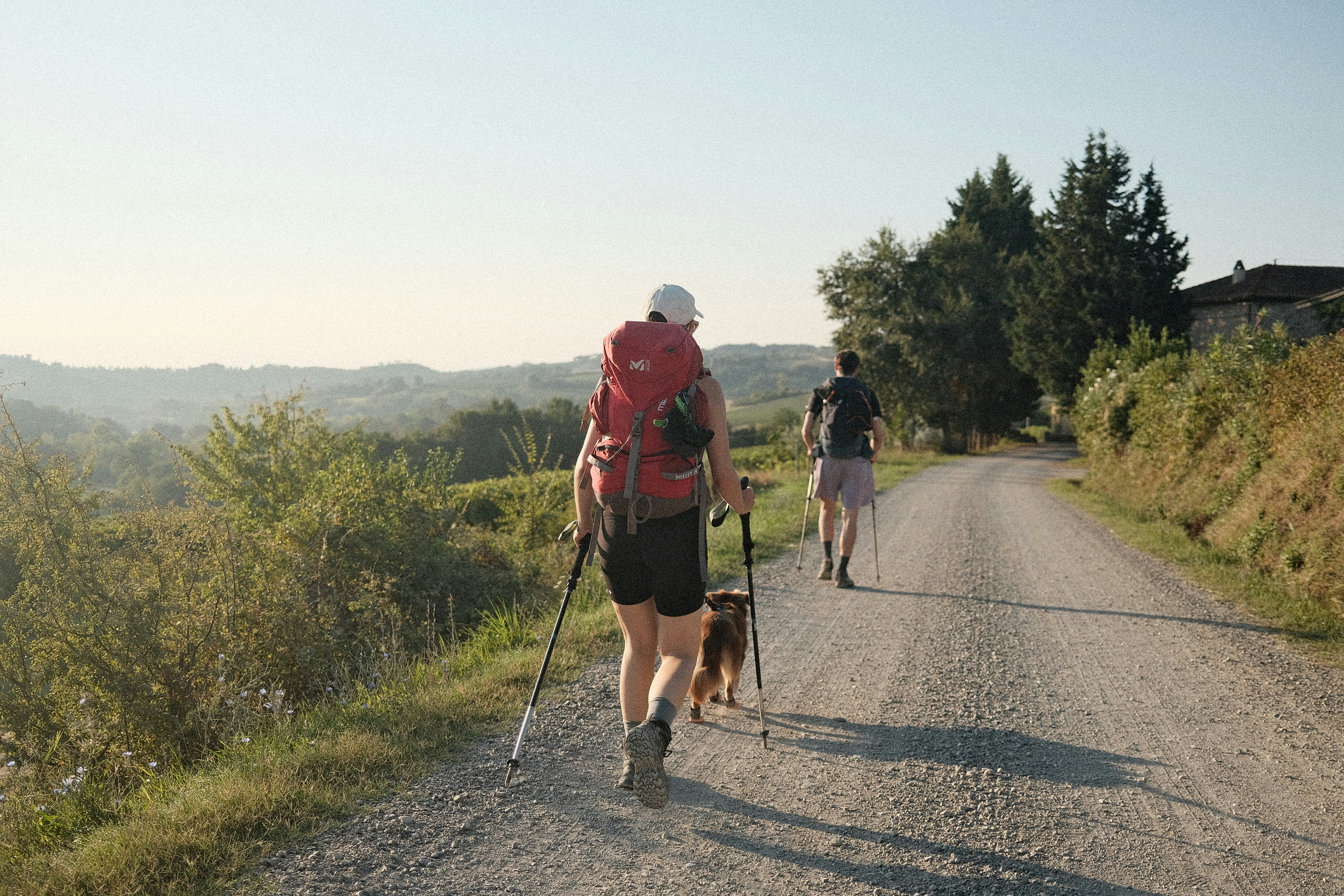 A couple of people walking down a dirt road photo – Free Man Image on ...