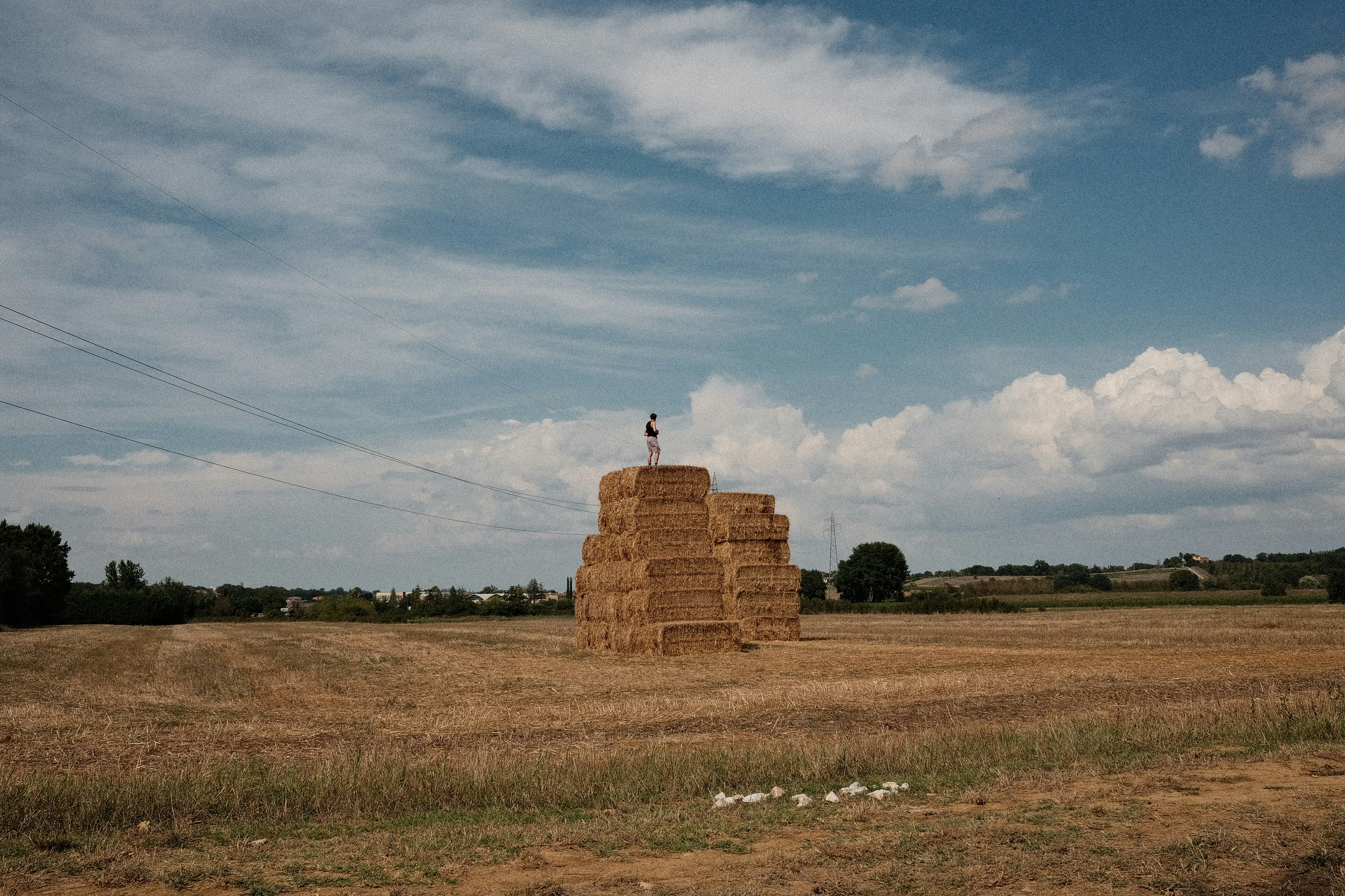 A large stack of hay sitting in a field photo – Free Land Image on Unsplash