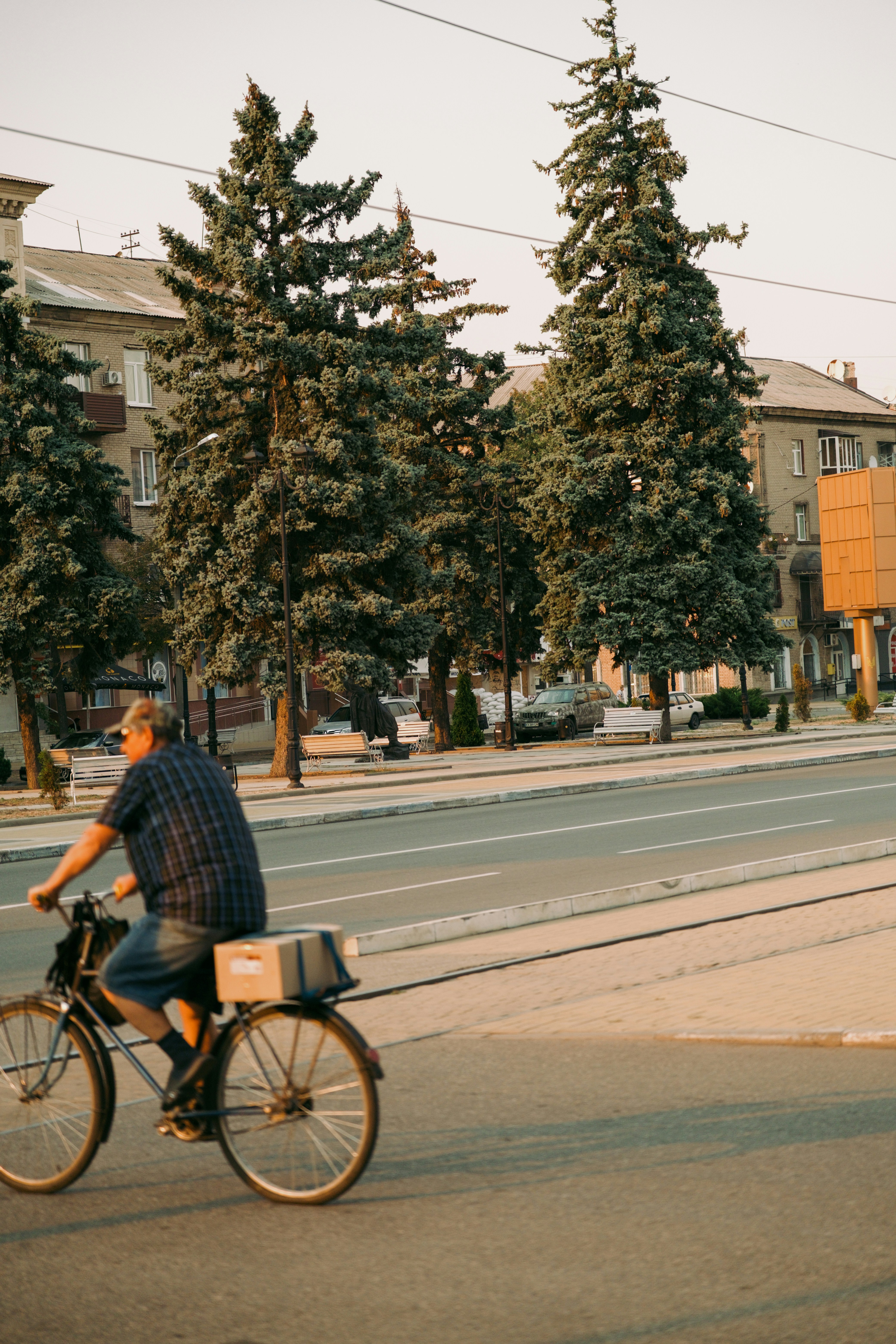 A man riding a bike down a street
