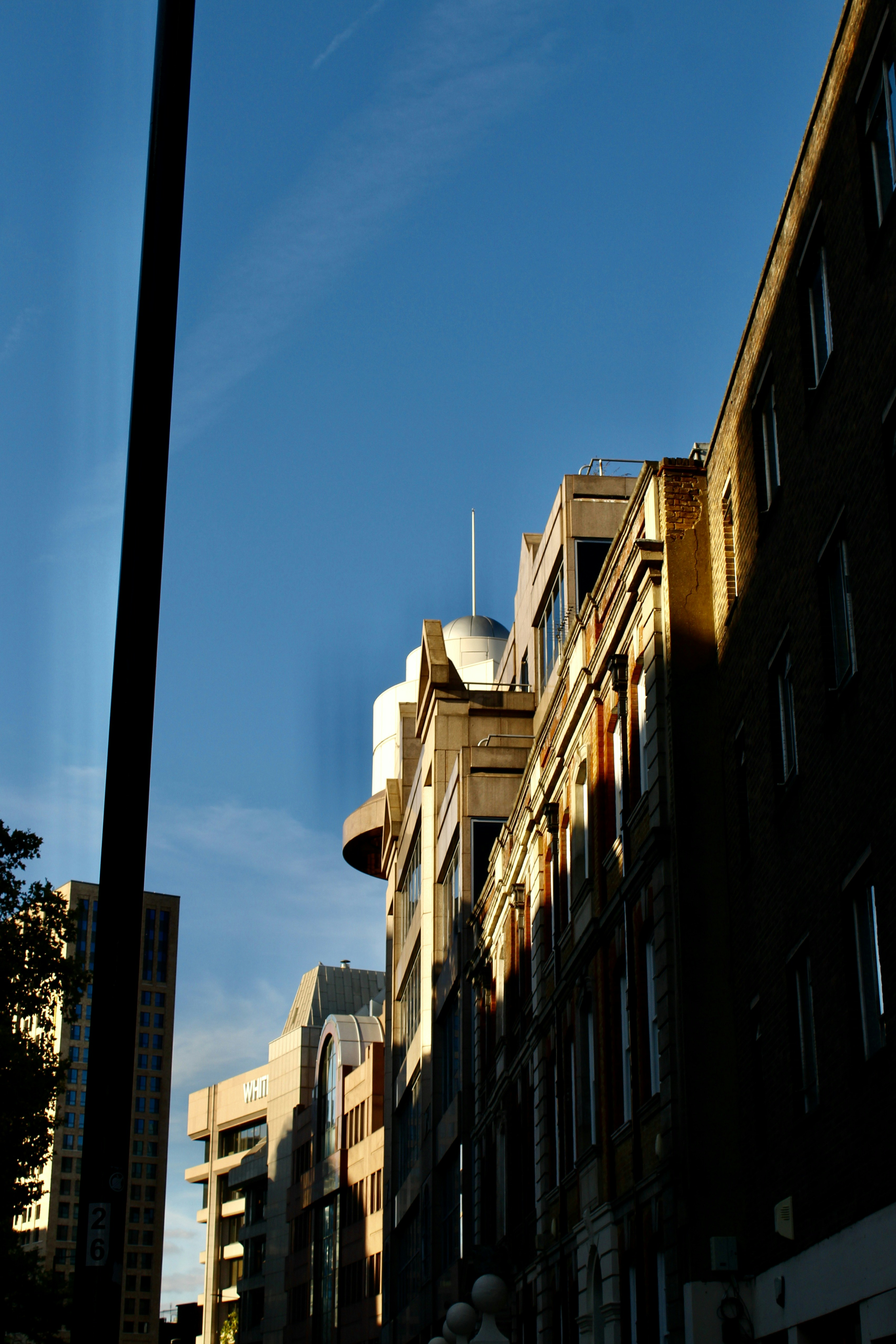 Apricot Light on Brick and Glass: A City Canyon Bathed in Late Afternoon Sun
