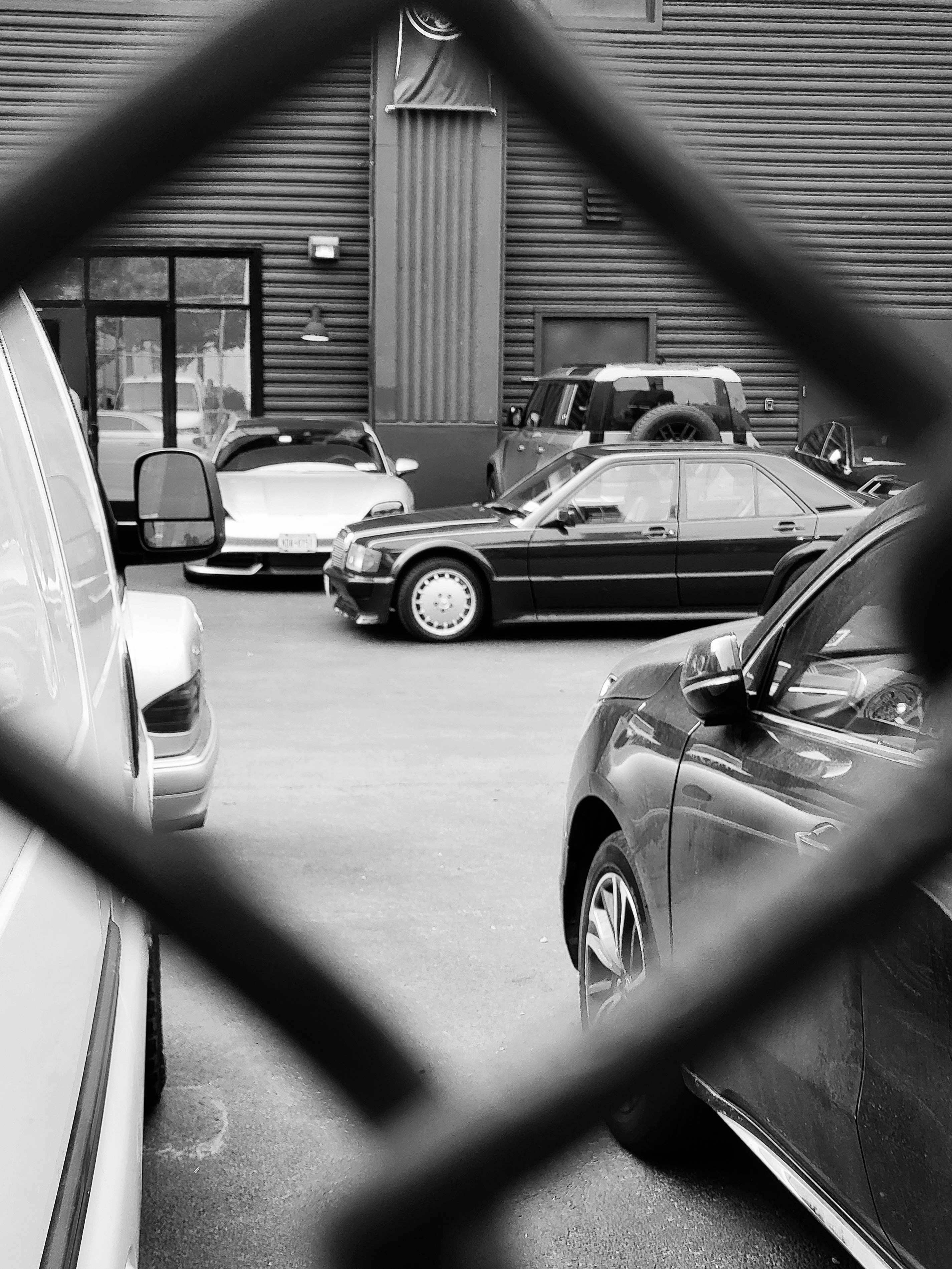 Through the Diamond Frame: Cars in a Parking Lot Framed by a Lattice