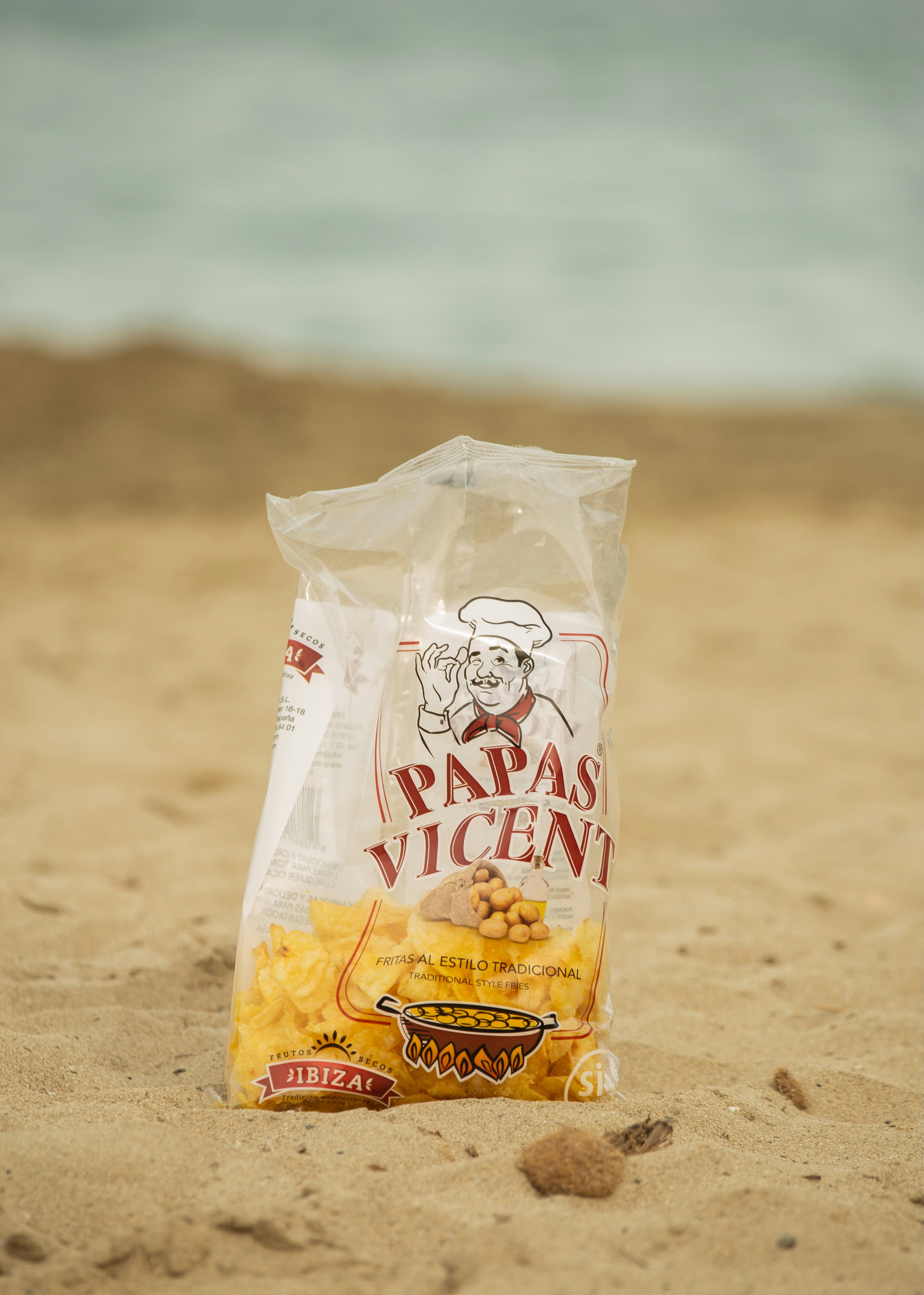A bag of pasta sitting on top of a sandy beach photo – Free Chips Image ...