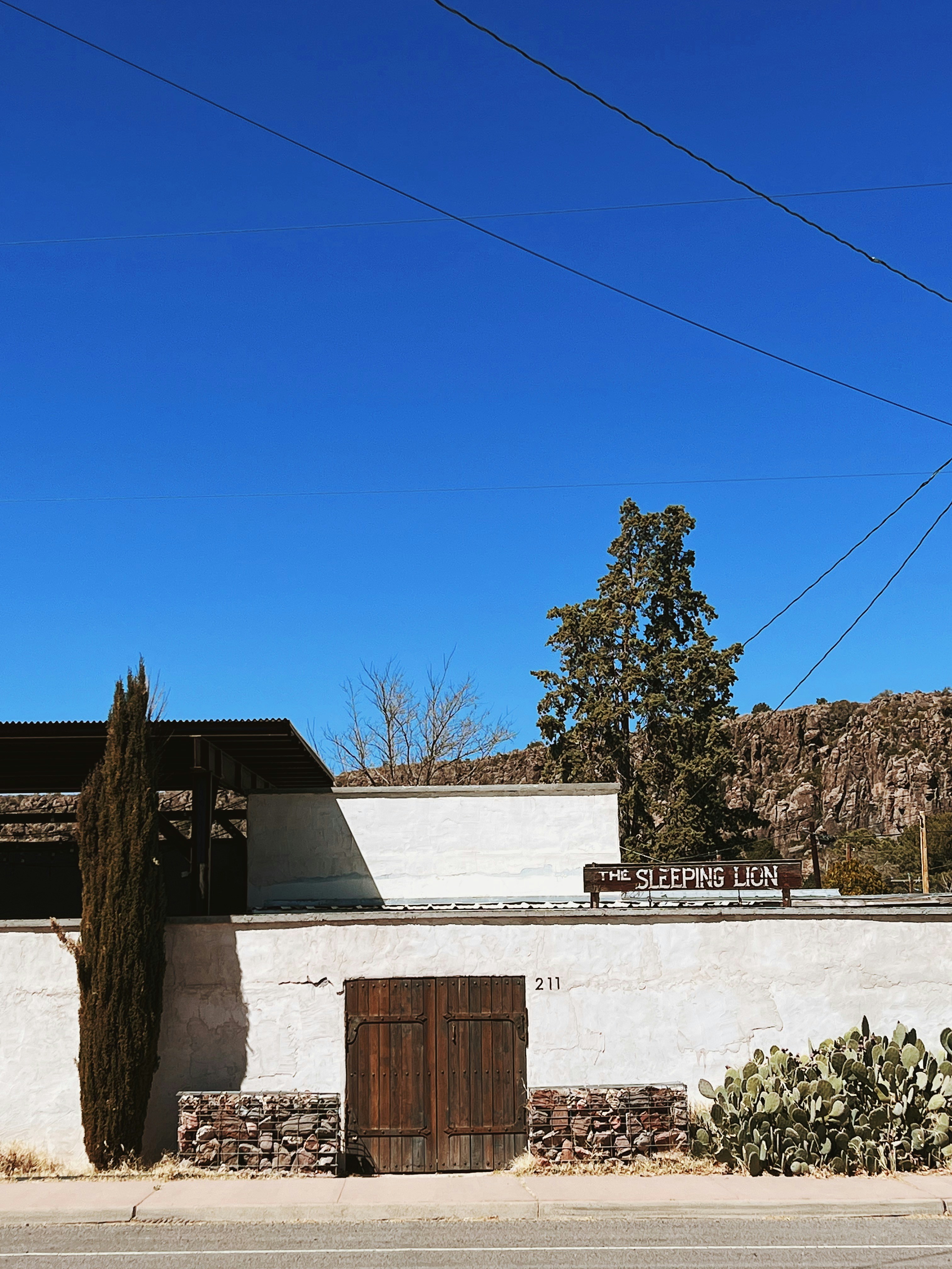 The Sleeping Lion: Sunlit Facade Beneath a Wide Blue Sky