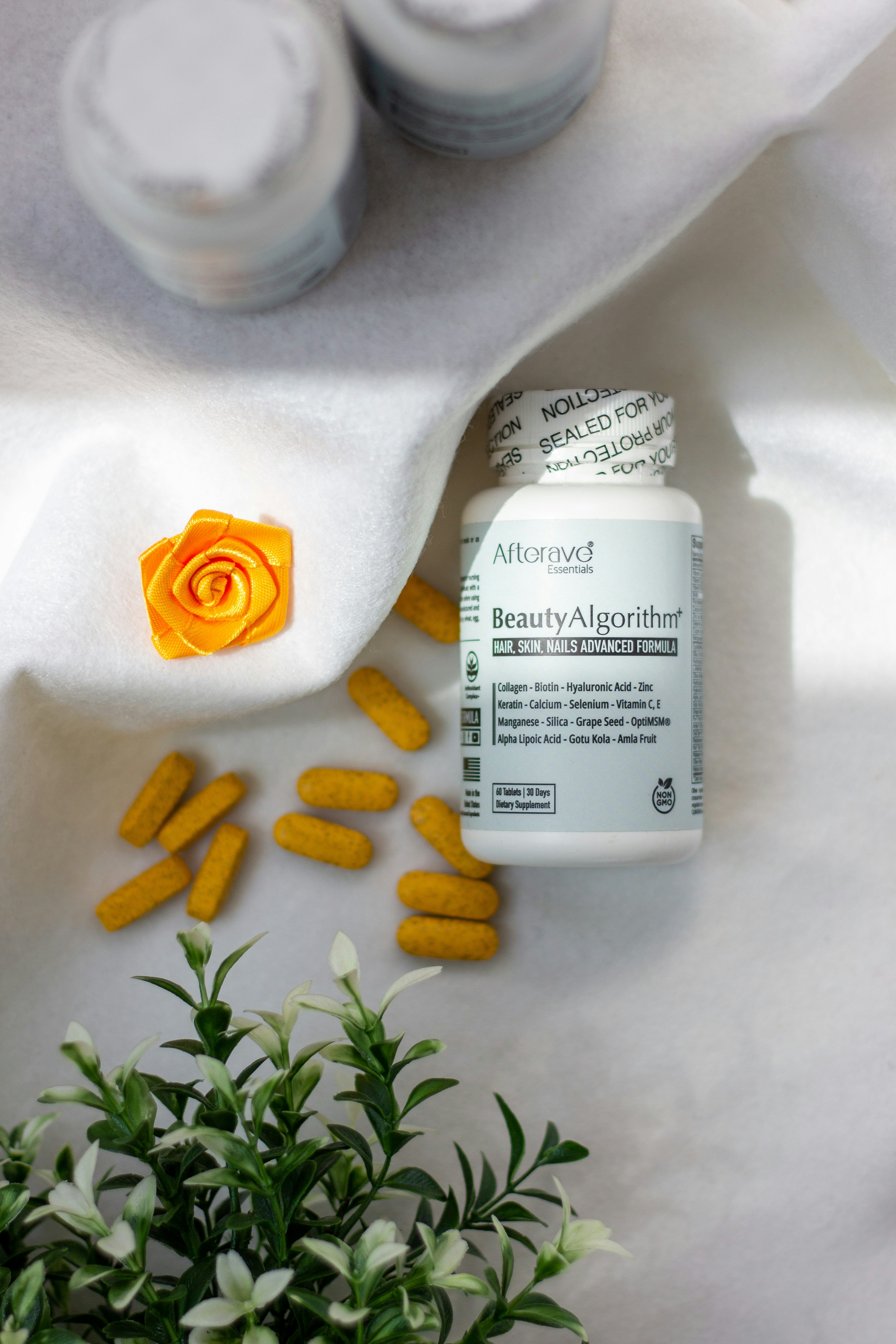 A bottle of vitamins sitting next to some pills photo – Free Flower Image on Unsplash