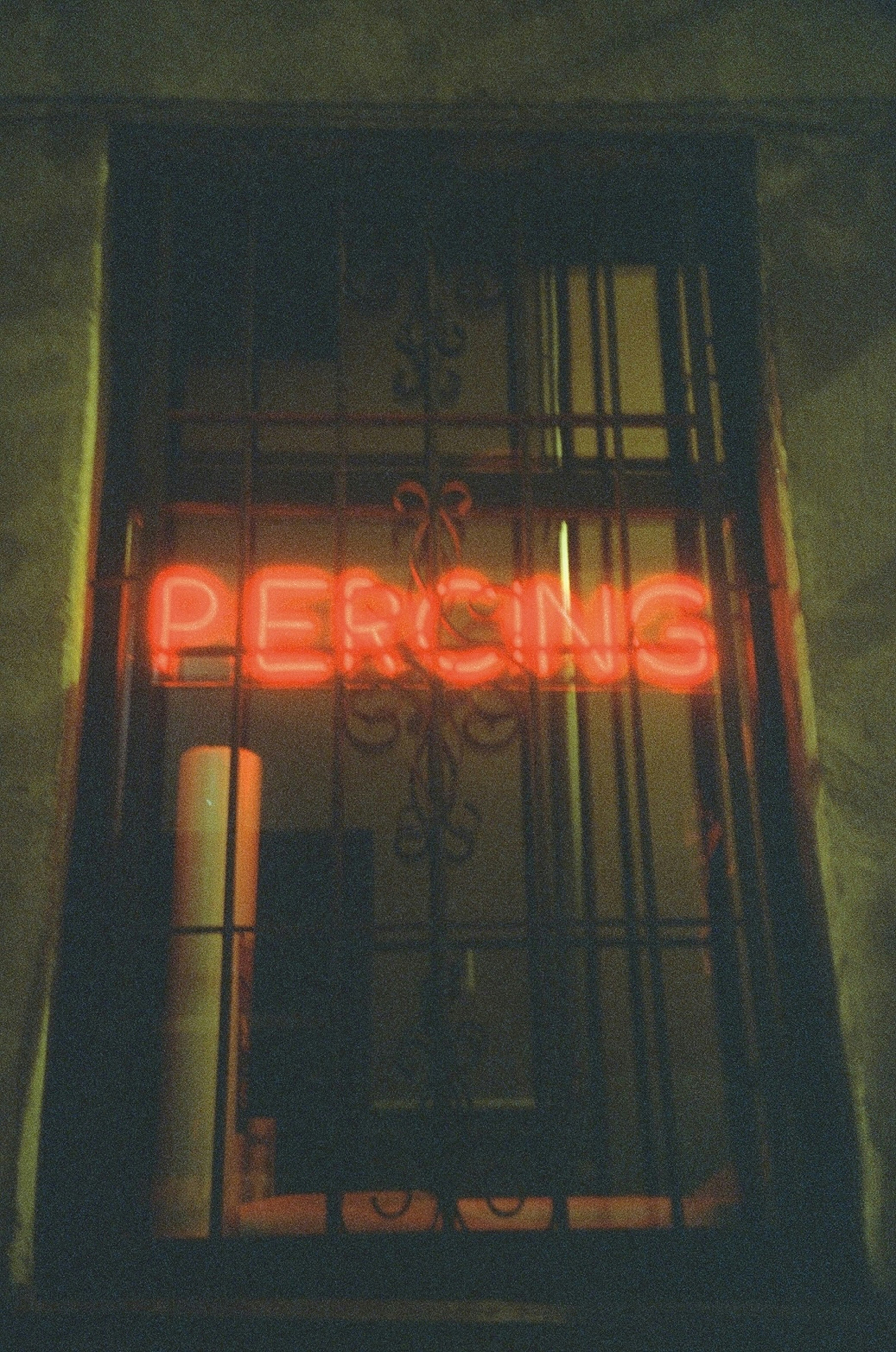 Neon Gate: Red Glow Through Bars