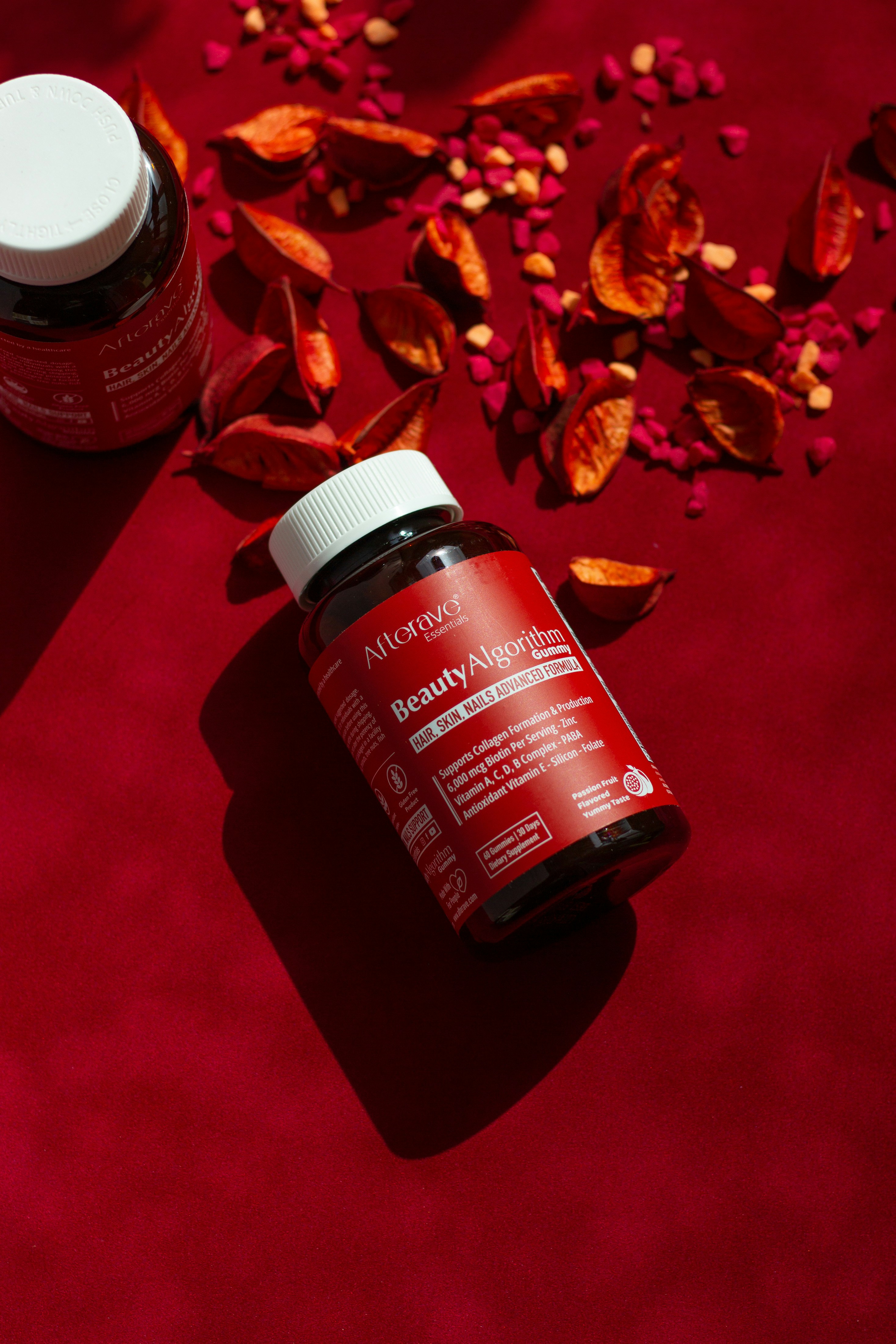 A bottle of vitamins sitting on top of a red table photo – Free ...