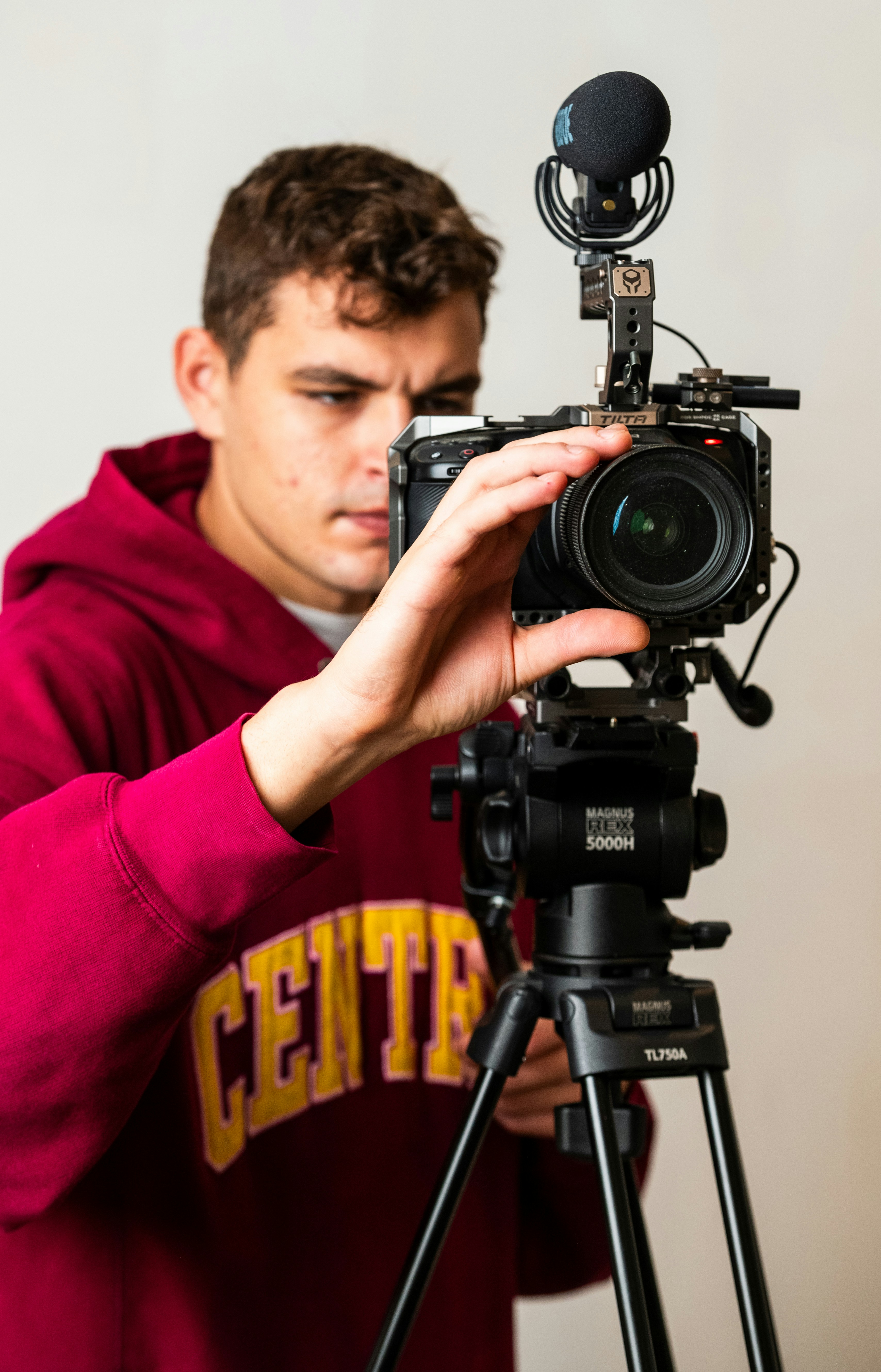 Precision Frame: A Teen Cameraman Aligns a Studio Rig