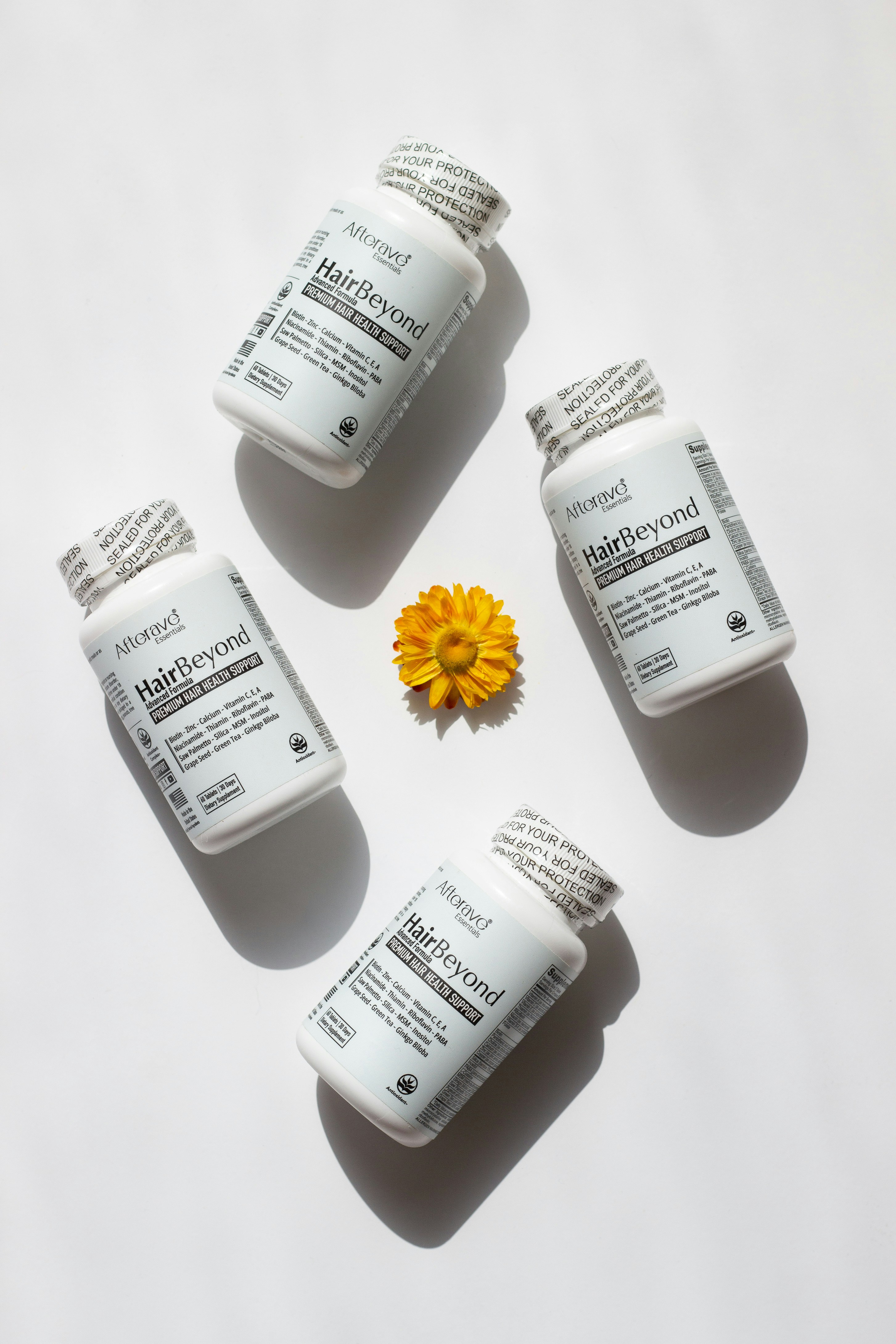 Four bottles of medicine with a yellow flower on top photo – Free ...