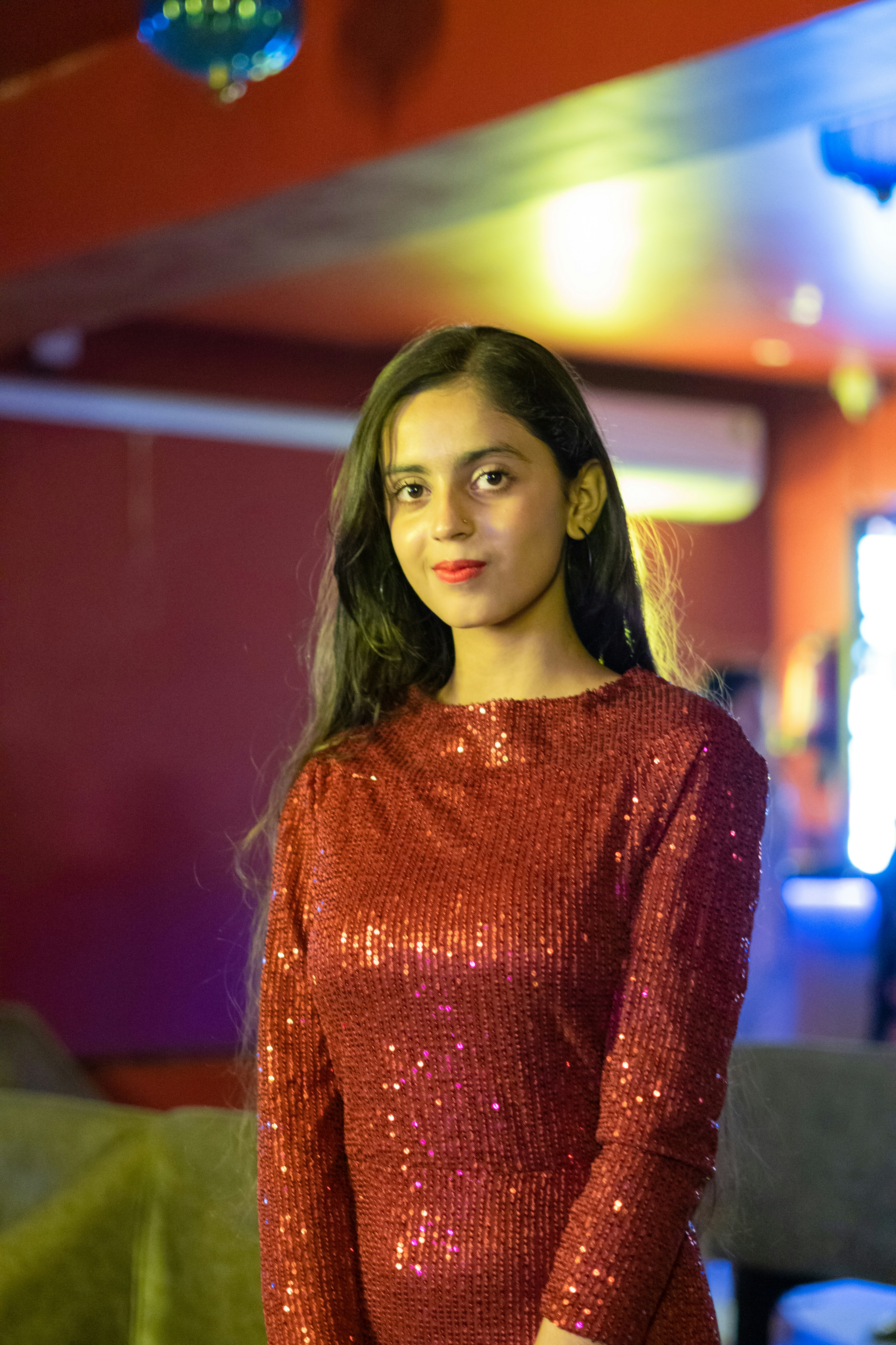 Sequined Red in Neon: A Poised Portrait in a Velvet Lounge