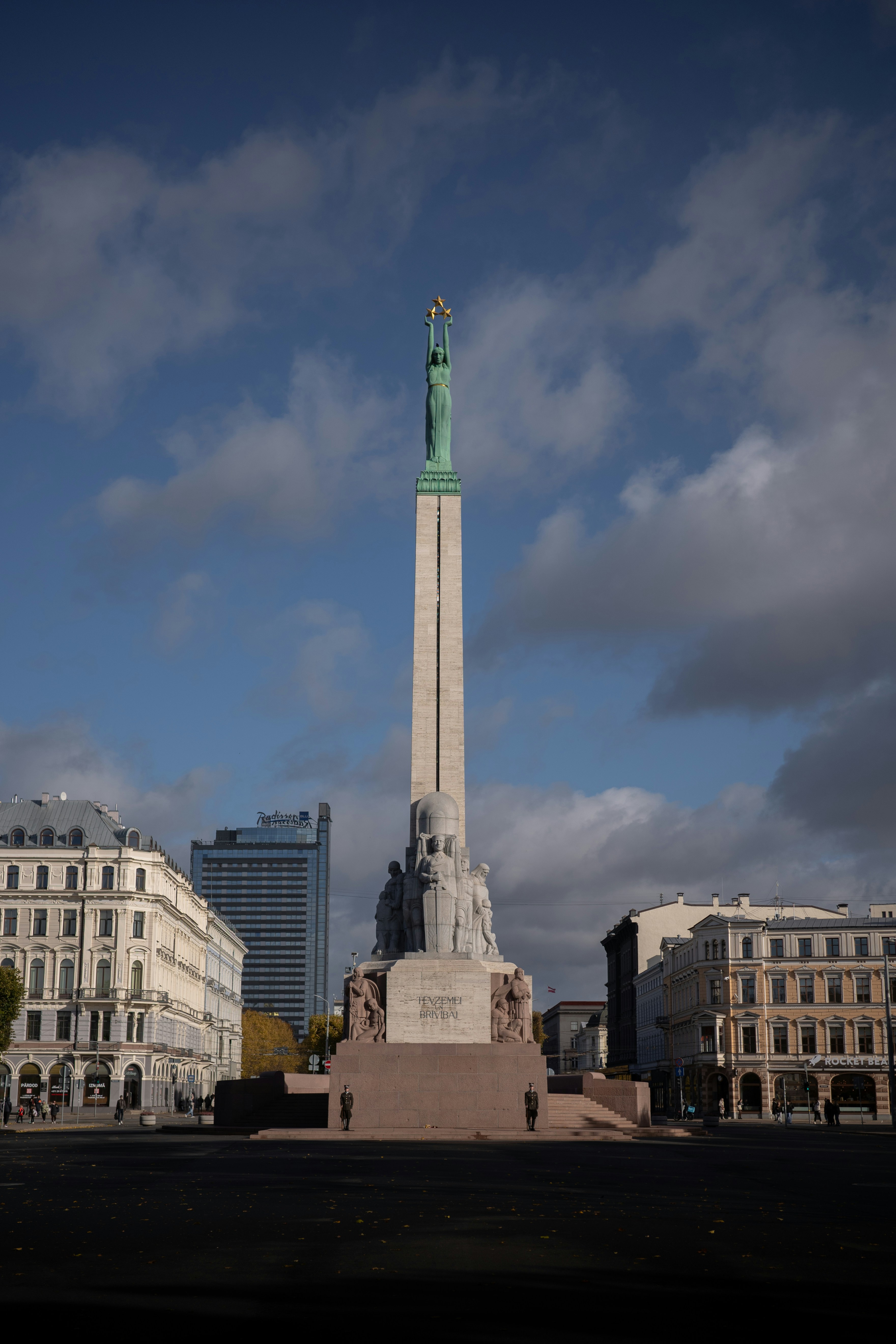 Rising Column of Stone and Bronze in a European Square