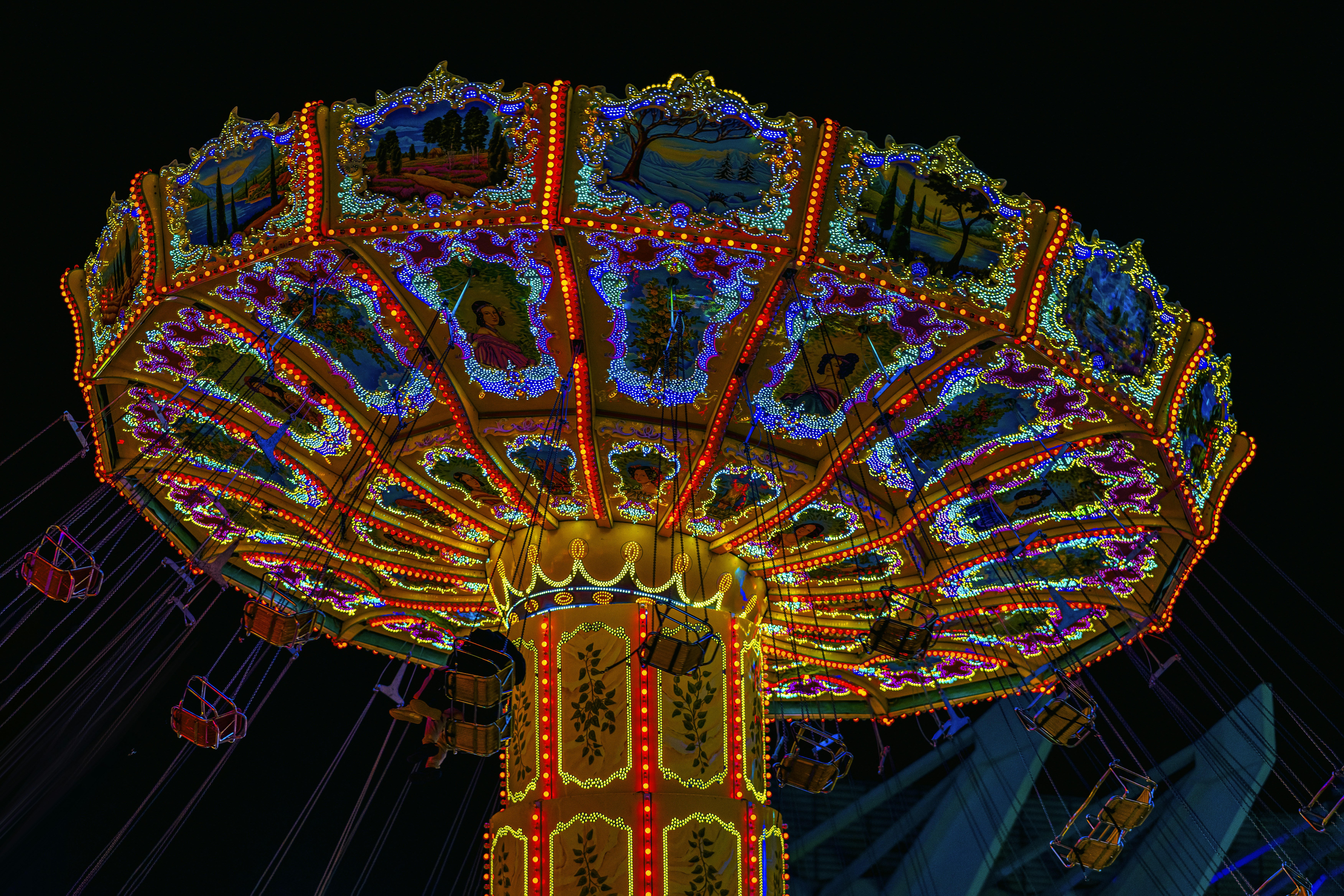 Illuminated Carousel Crown: Nightlit Spokes and Colorful Turrets