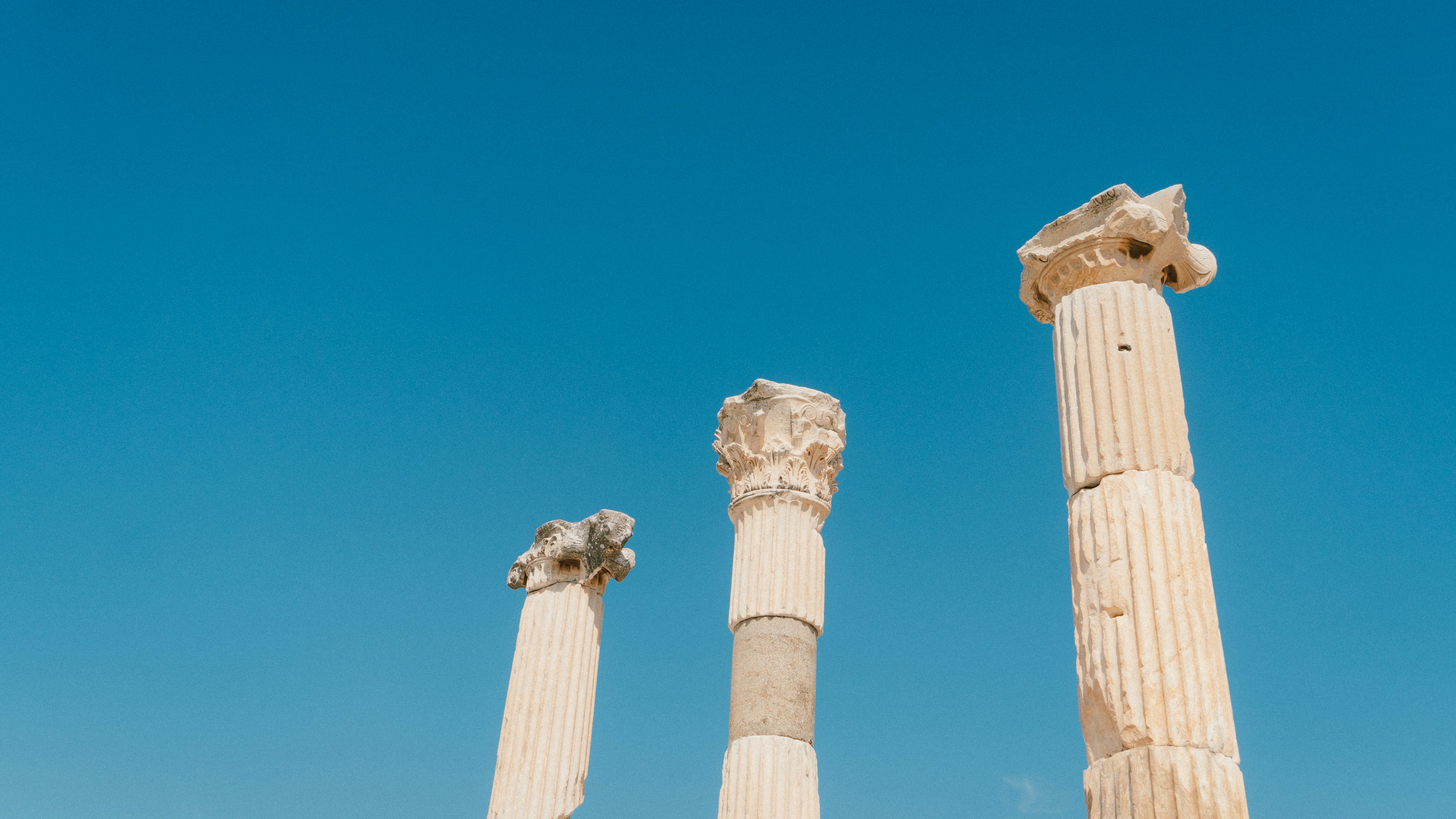 A couple of tall white pillars sitting next to each other photo – Free ...