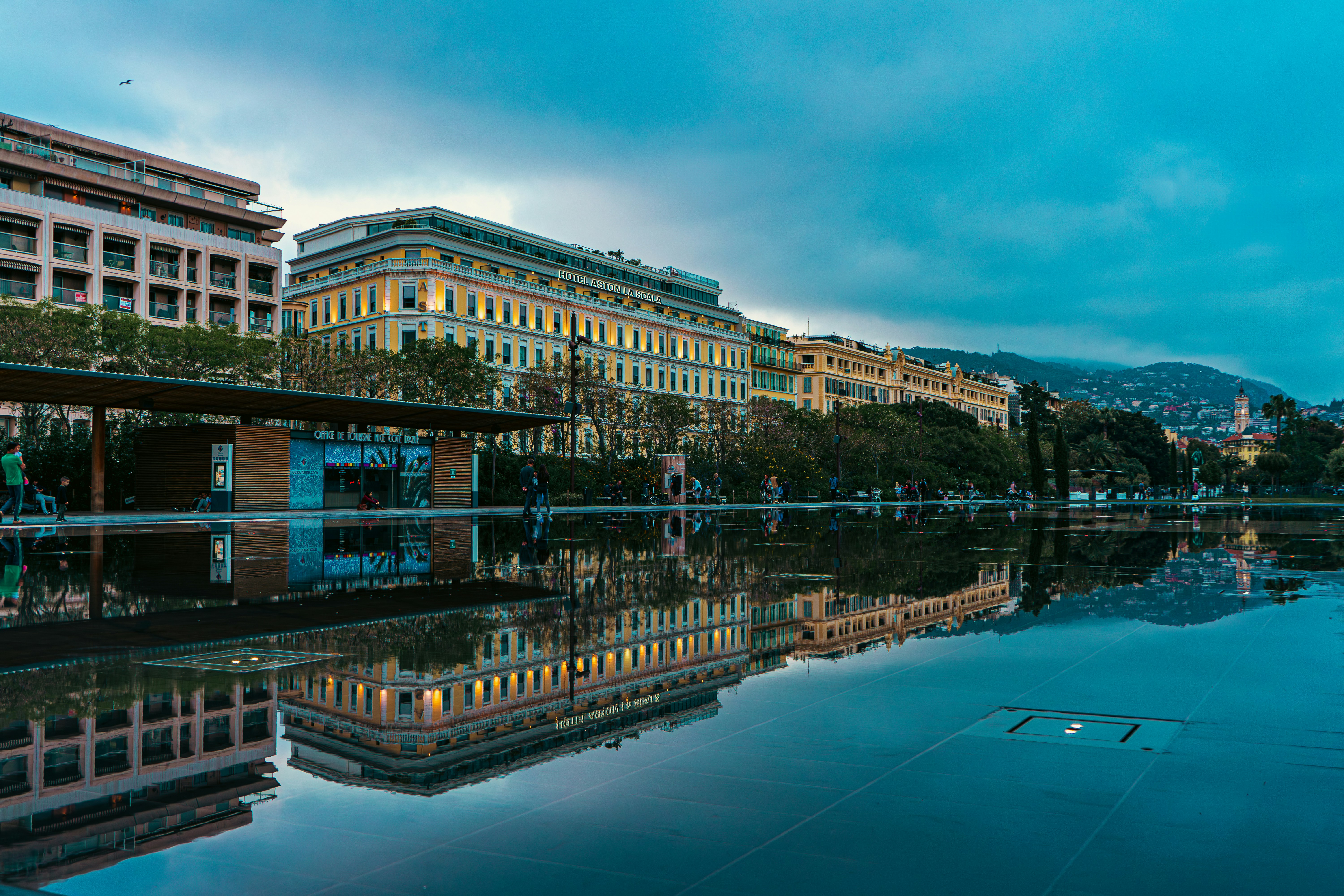 A body of water with buildings in the background photo – Free Nice ...