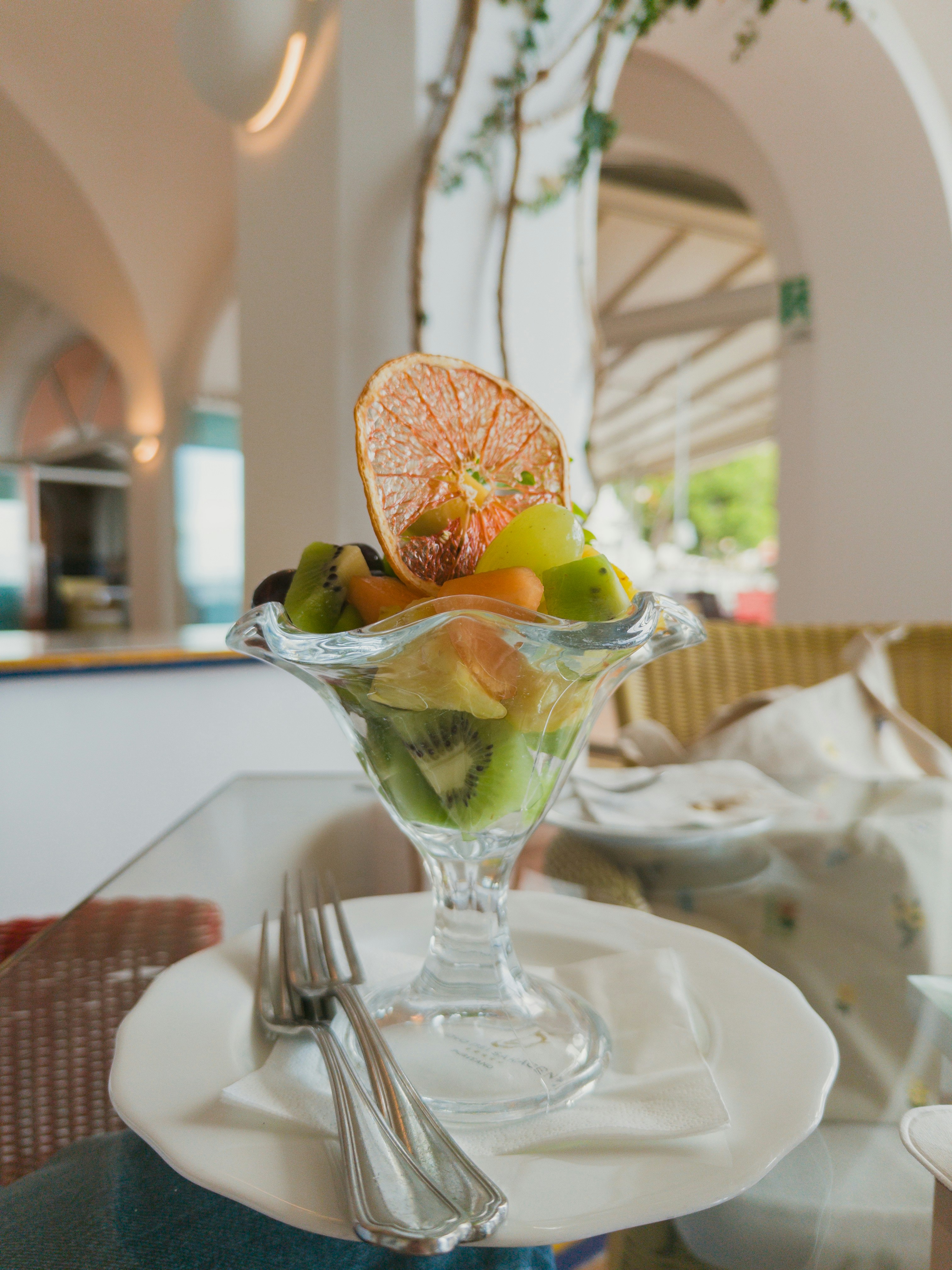 A bowl of fruit on a table in a restaurant photo – Free Cream Image on ...