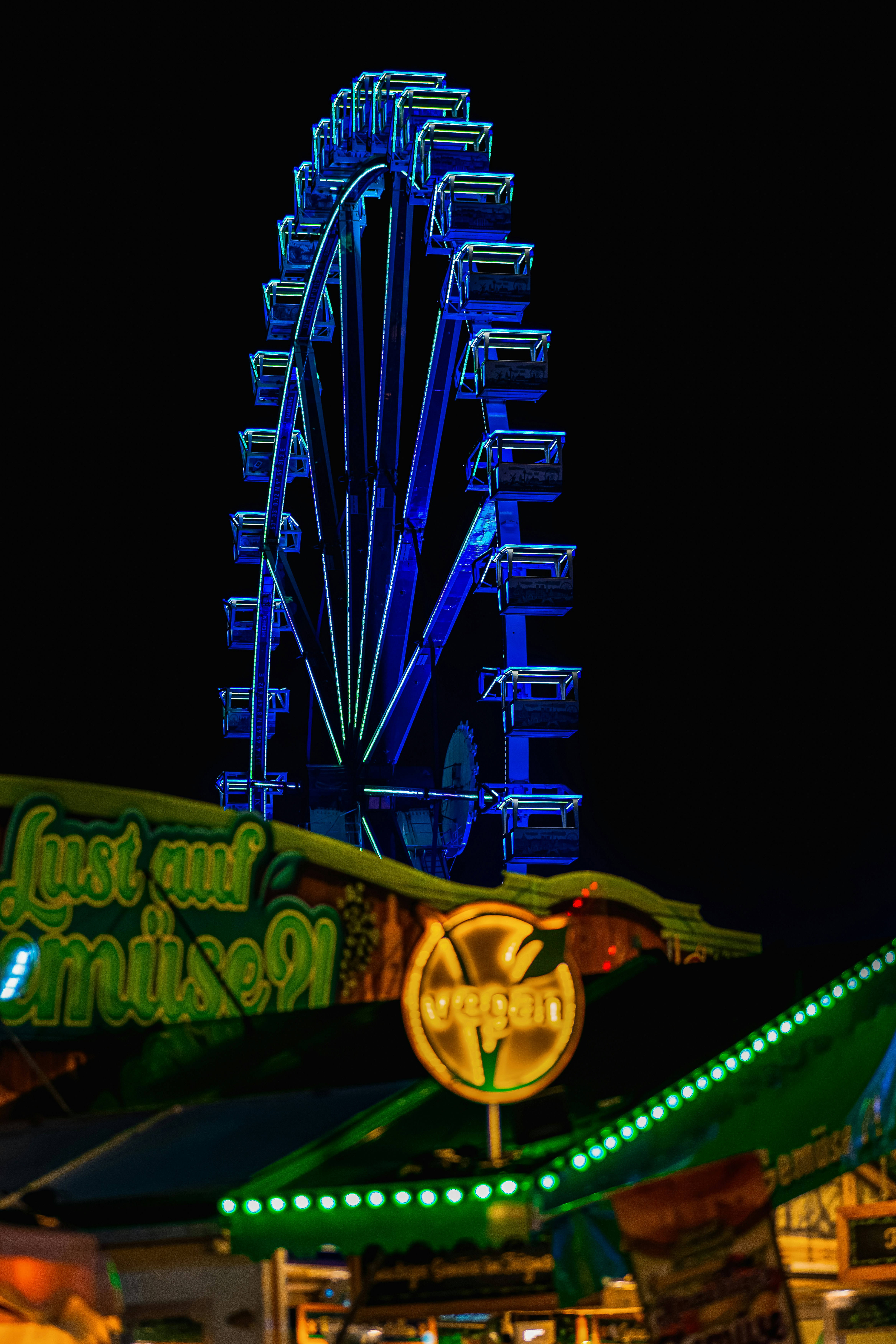Electric Blue Ferris Wheel Over a Neon Night Market