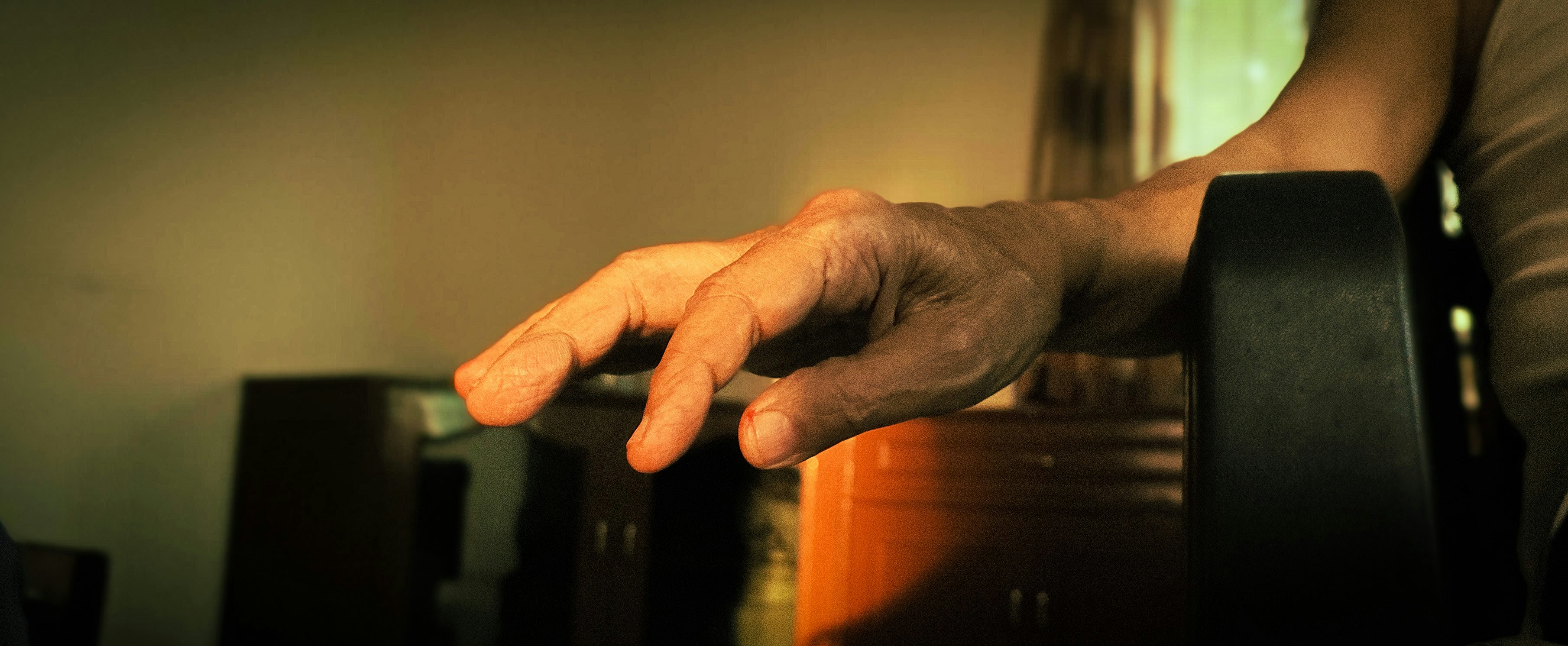 Low-light Hand in Focus: A Quiet Hand Reaches for the Edge of a Dim Scene