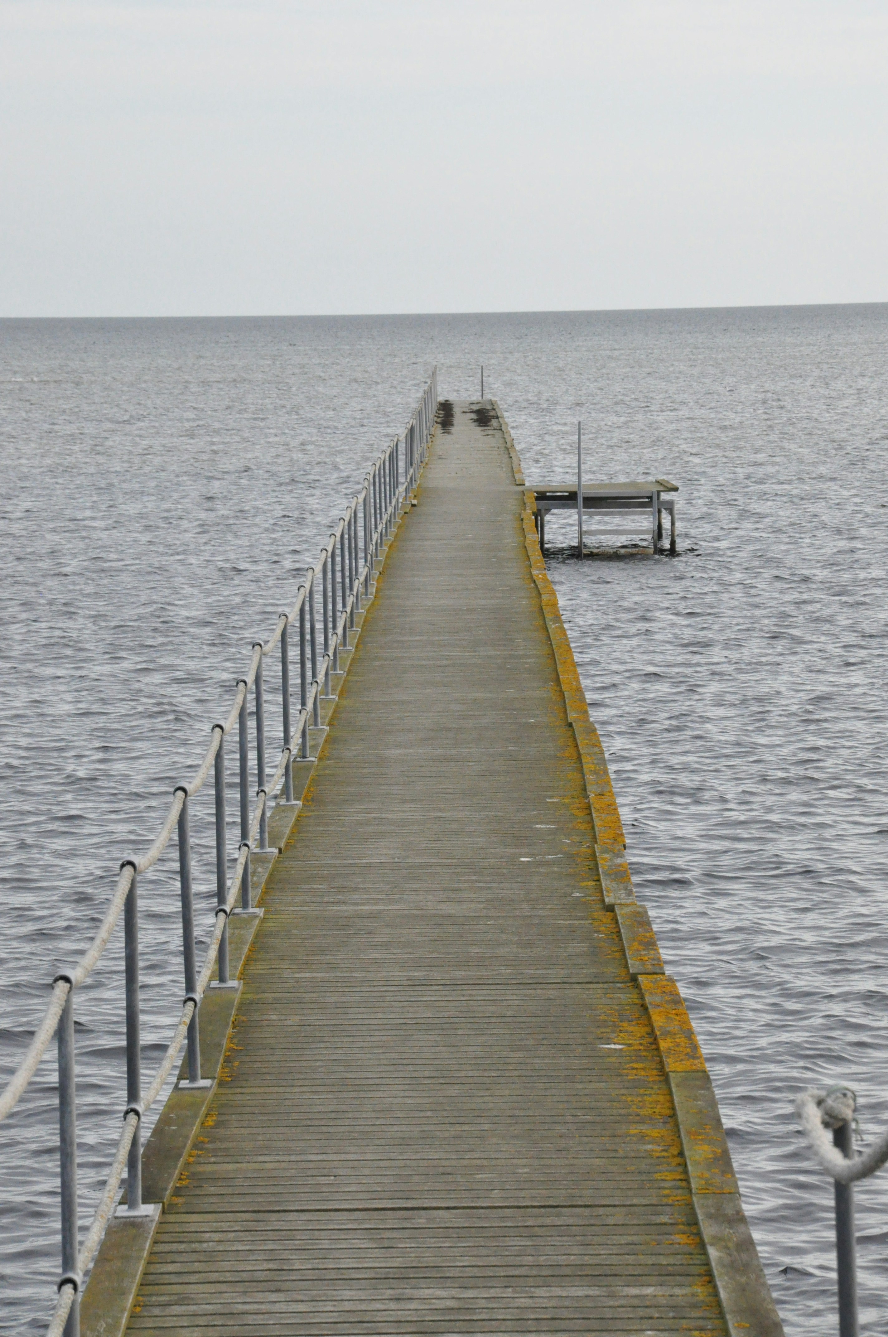 Weathered Pier Reaching Toward a Distant Quiet Sea