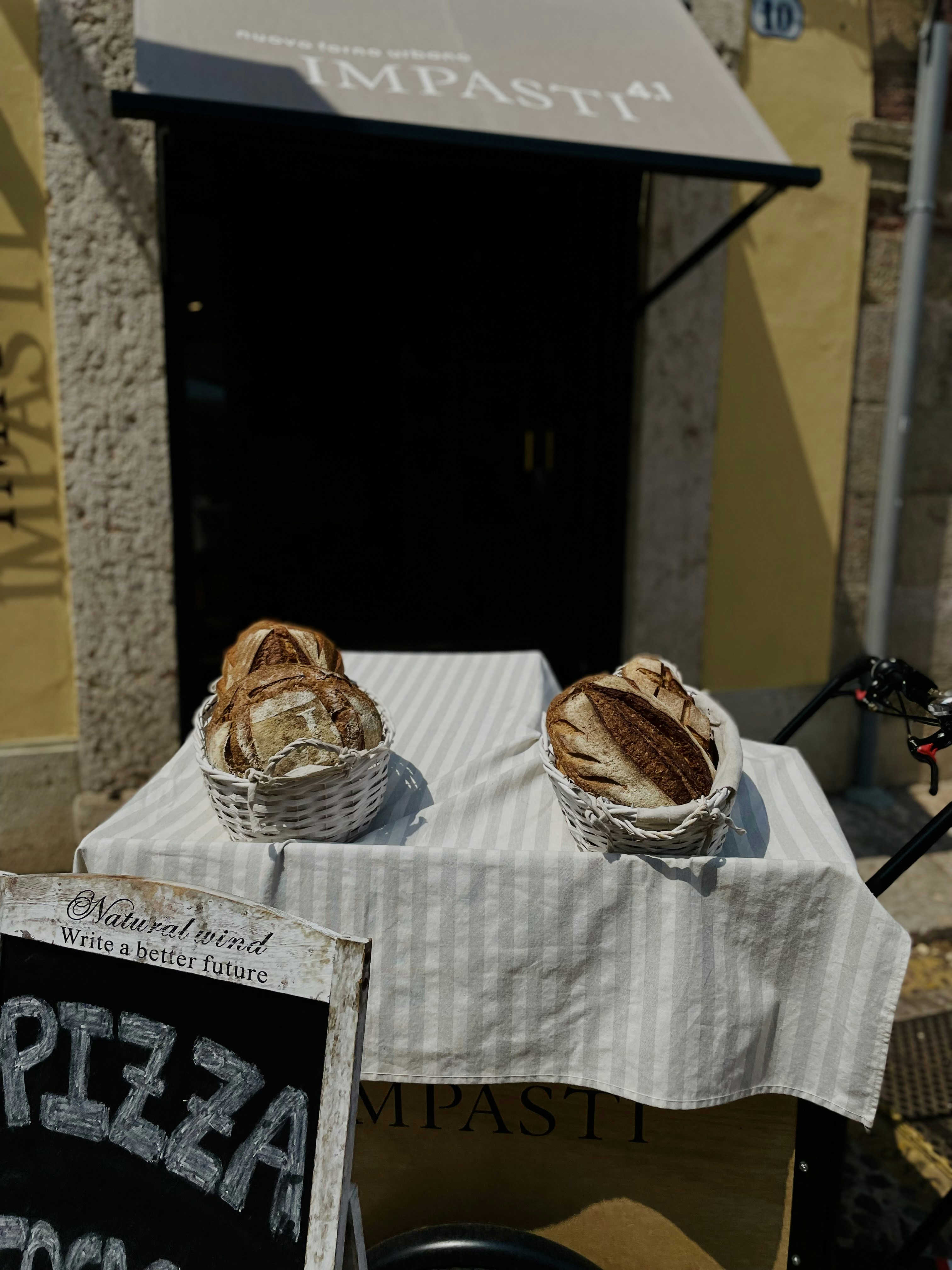 Crusty Boules on a Striped Table: Quiet Corner of a Trattoria