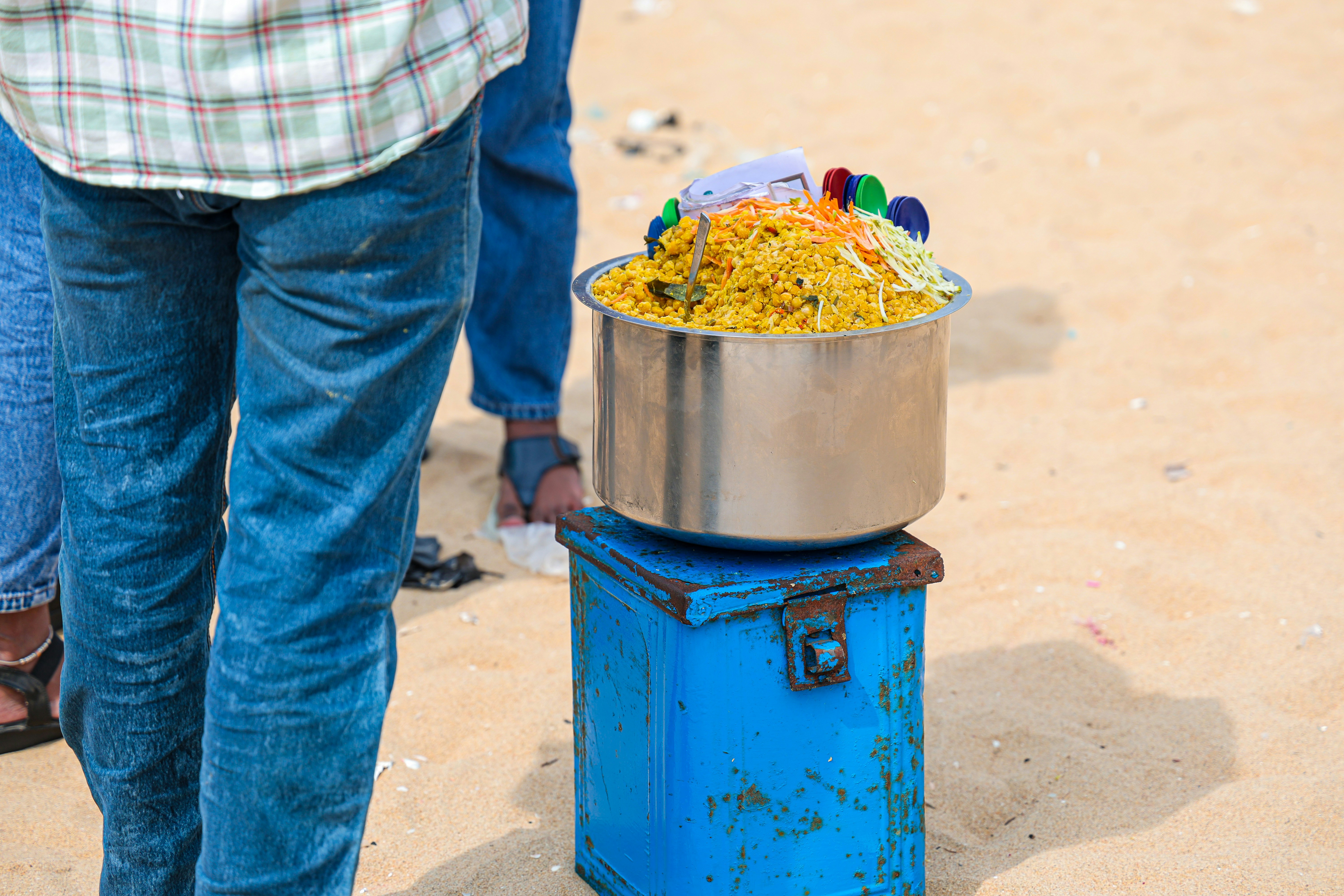 Saffron Rice Pot Perched on a Weathered Cobalt Pedestal at a Sunlit Street Stall