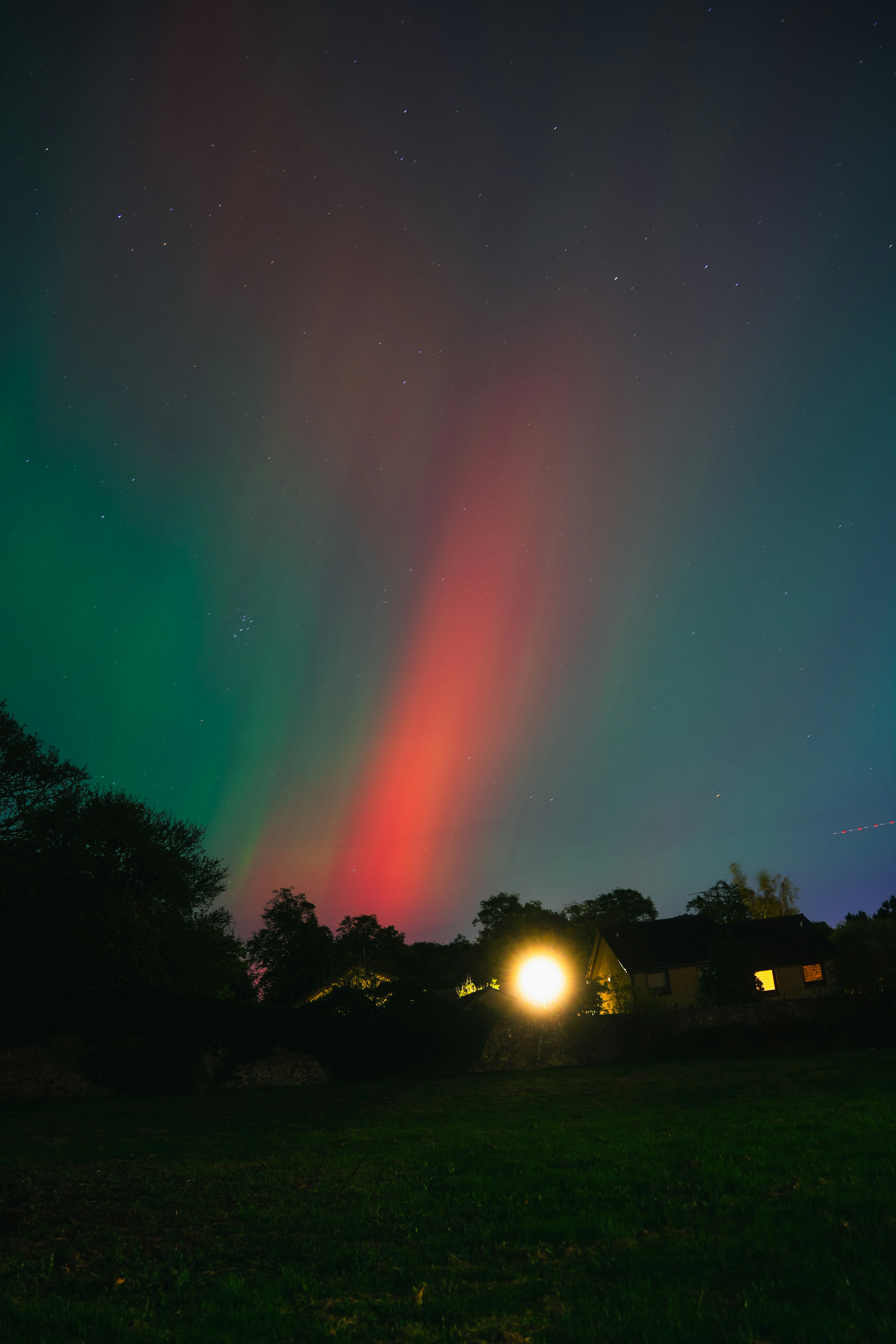 A green and red light shines in the night sky photo – Free Nature Image ...