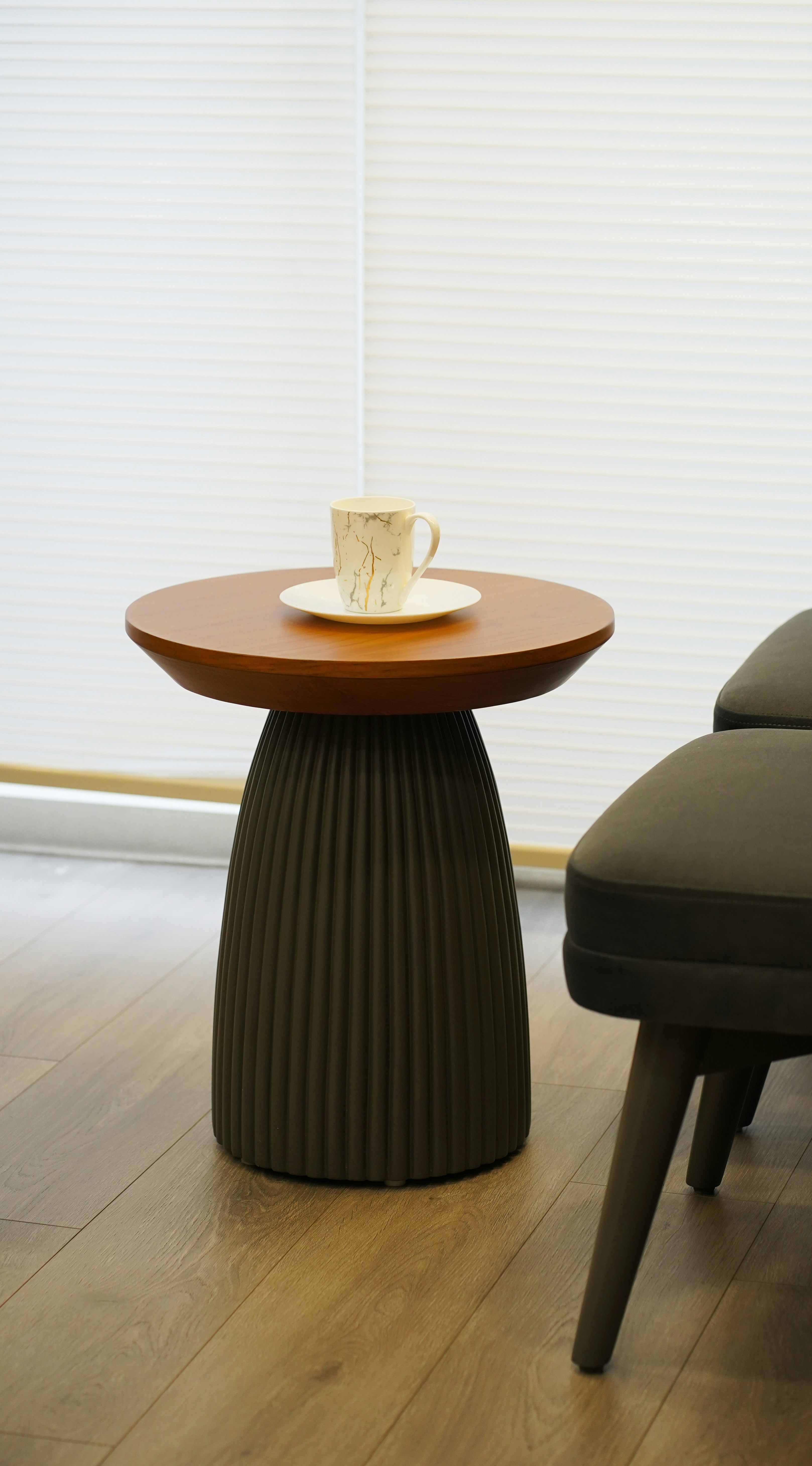 Ceramic Cup on a Ribbed Pedestal Table in Quiet Minimalism