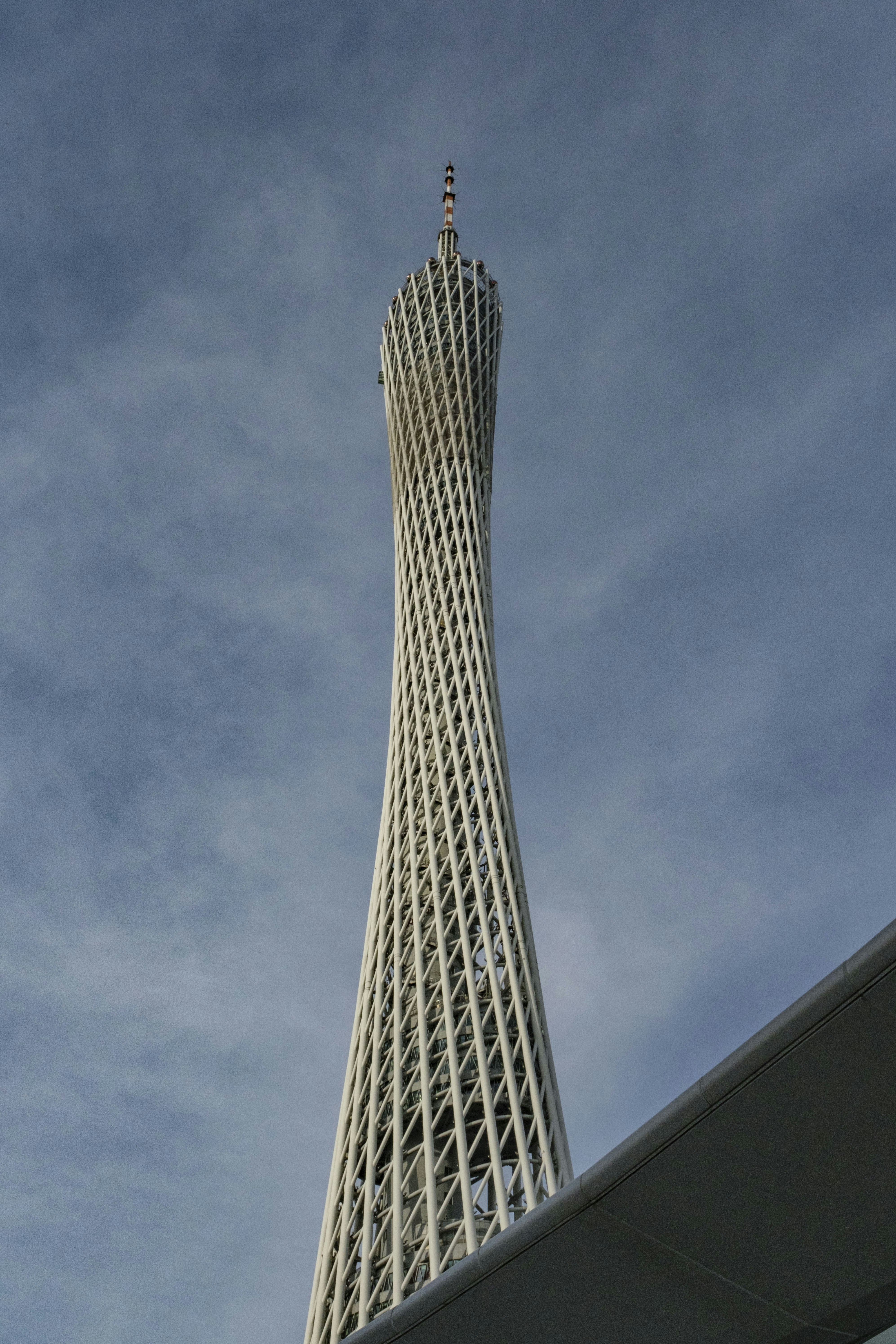 Diamond-weave tower ascends into a clear blue sky
