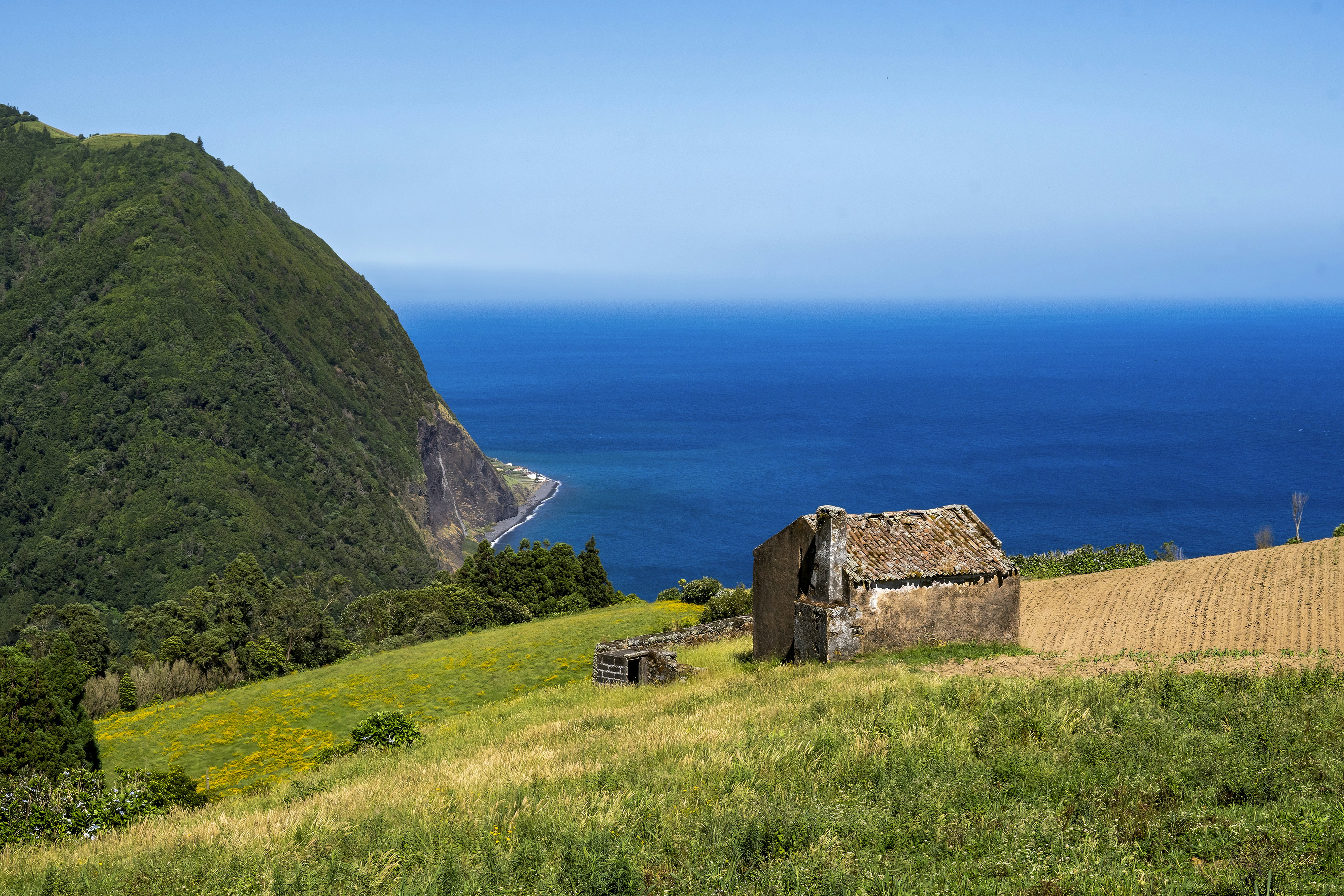Stone Hut on a Sunlit Hilltop Overlooking the Cobalt Atlantic