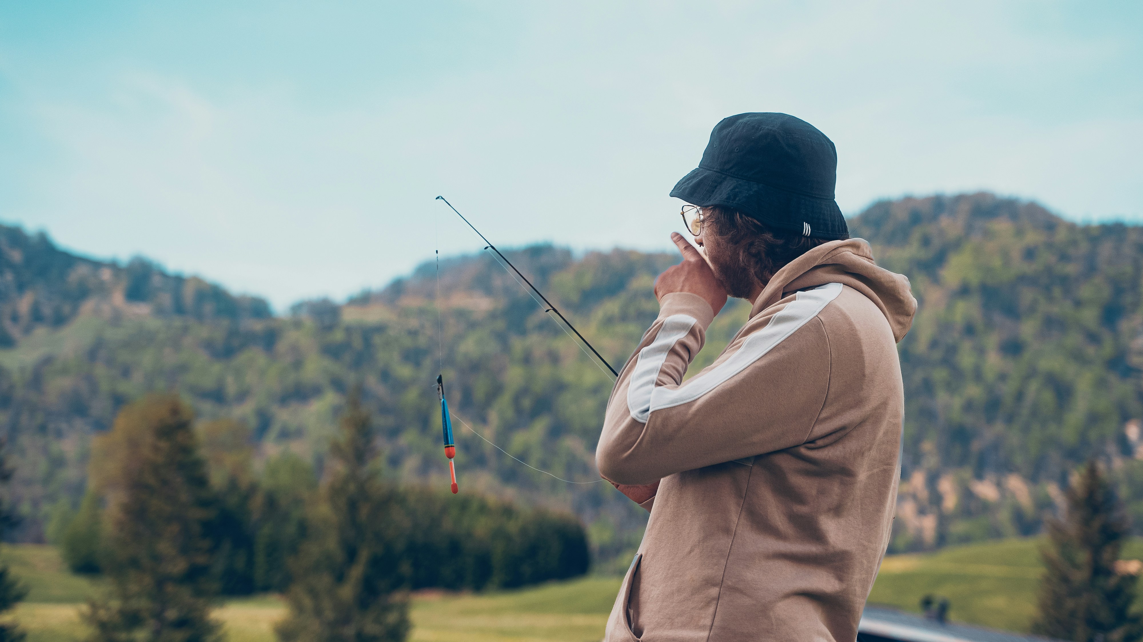 Lone Angler Casting Toward the Distant Hills