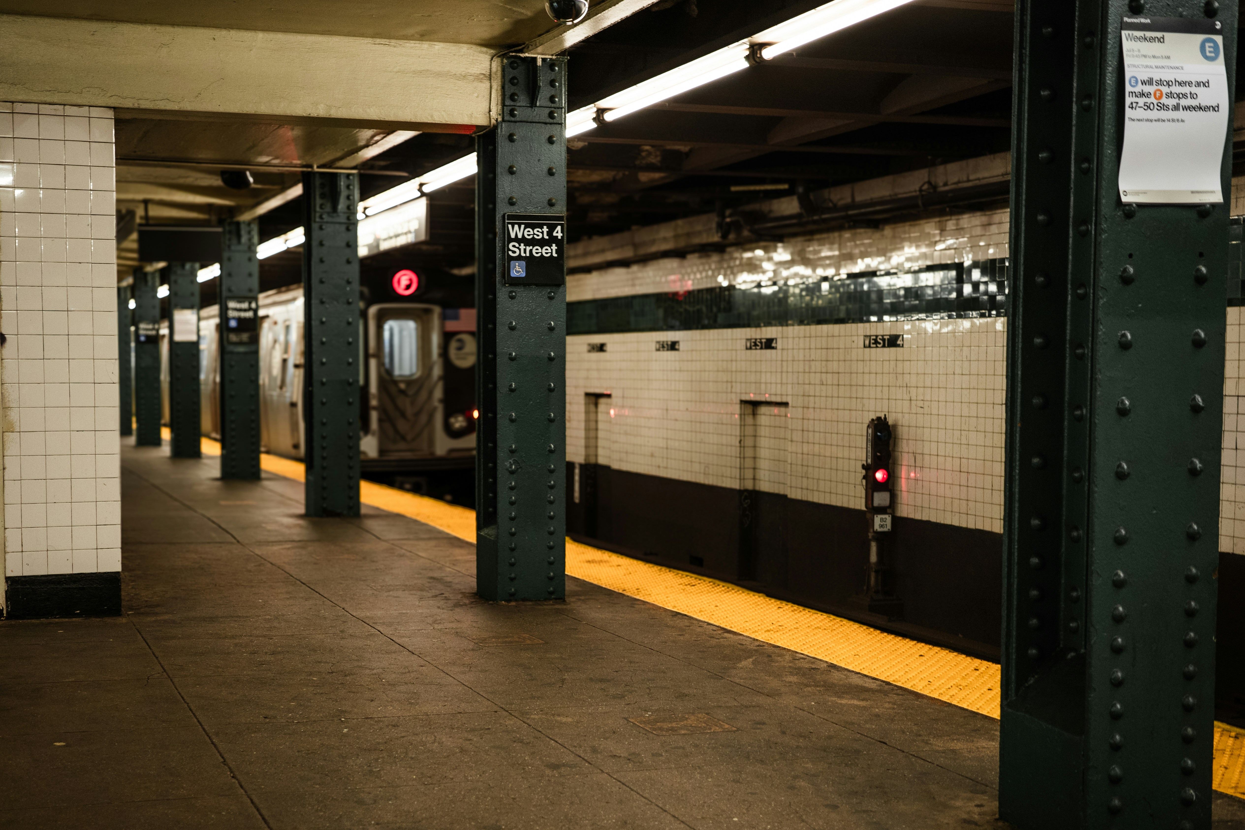 A subway station with a train pulling into the station photo – Free New york Image on Unsplash