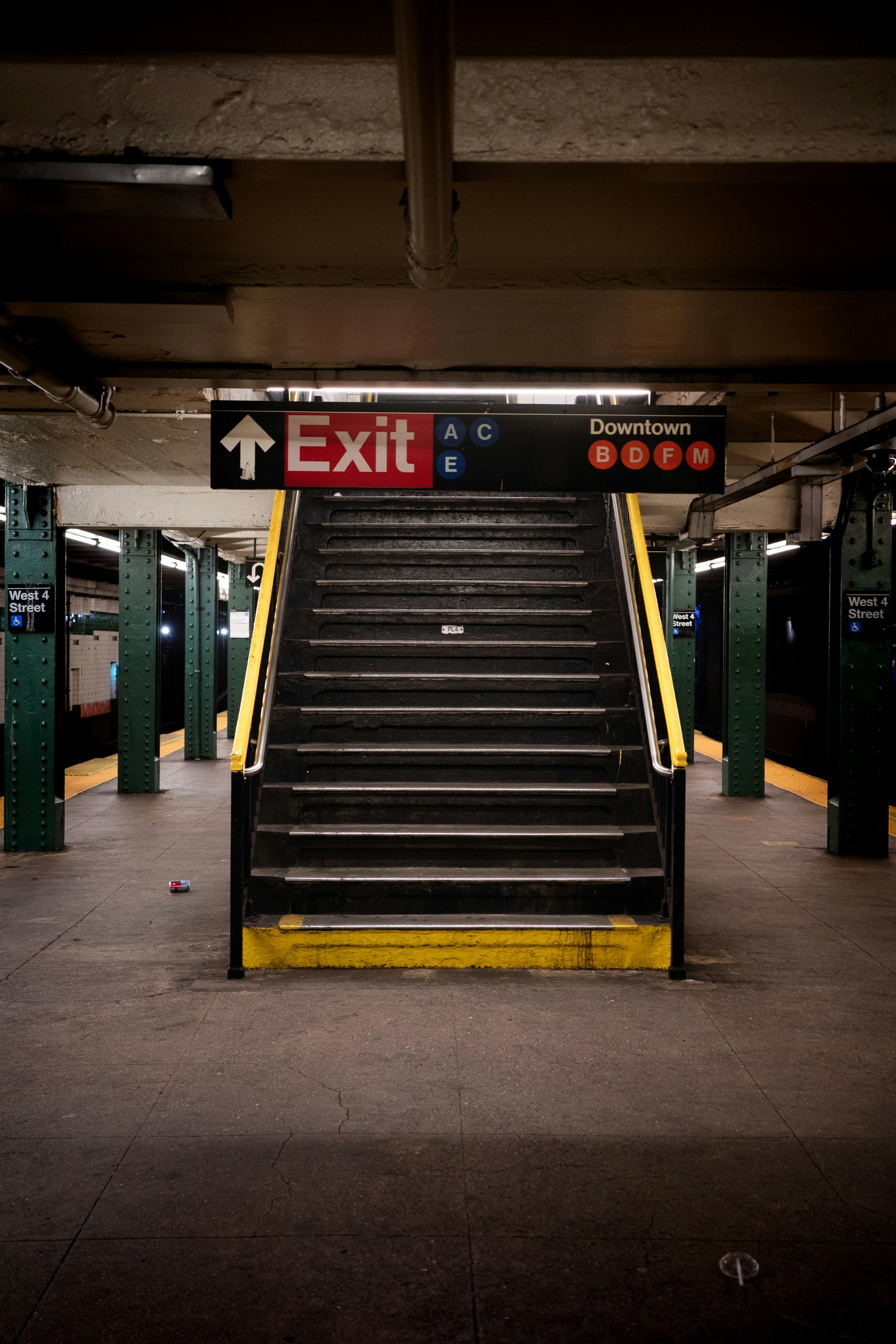 An escalator in a subway station with a red exit sign photo – Free New ...