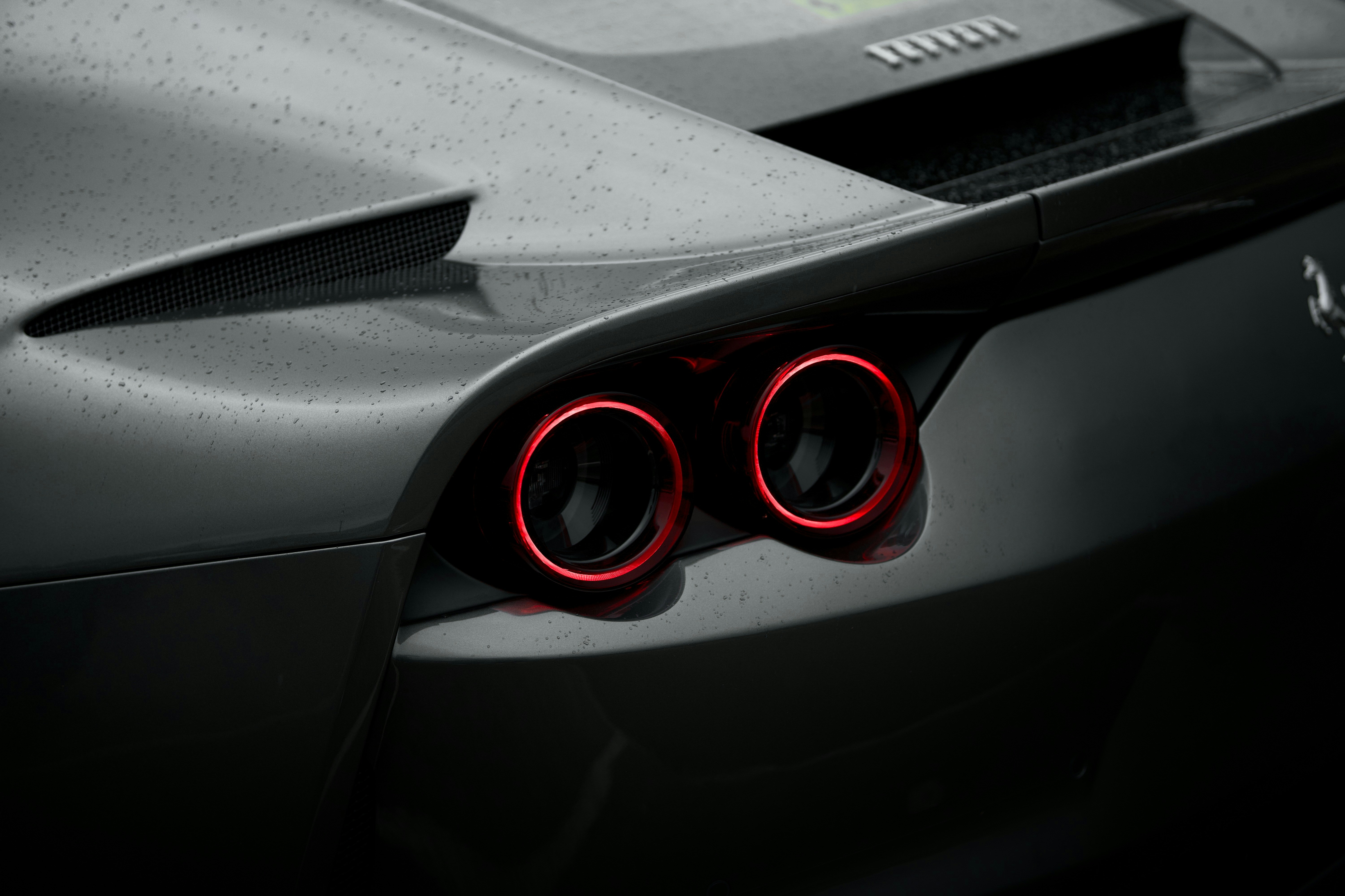 Close-up of the Ferrari 812 Superfast's rear with dual exhausts and aerodynamic lines.