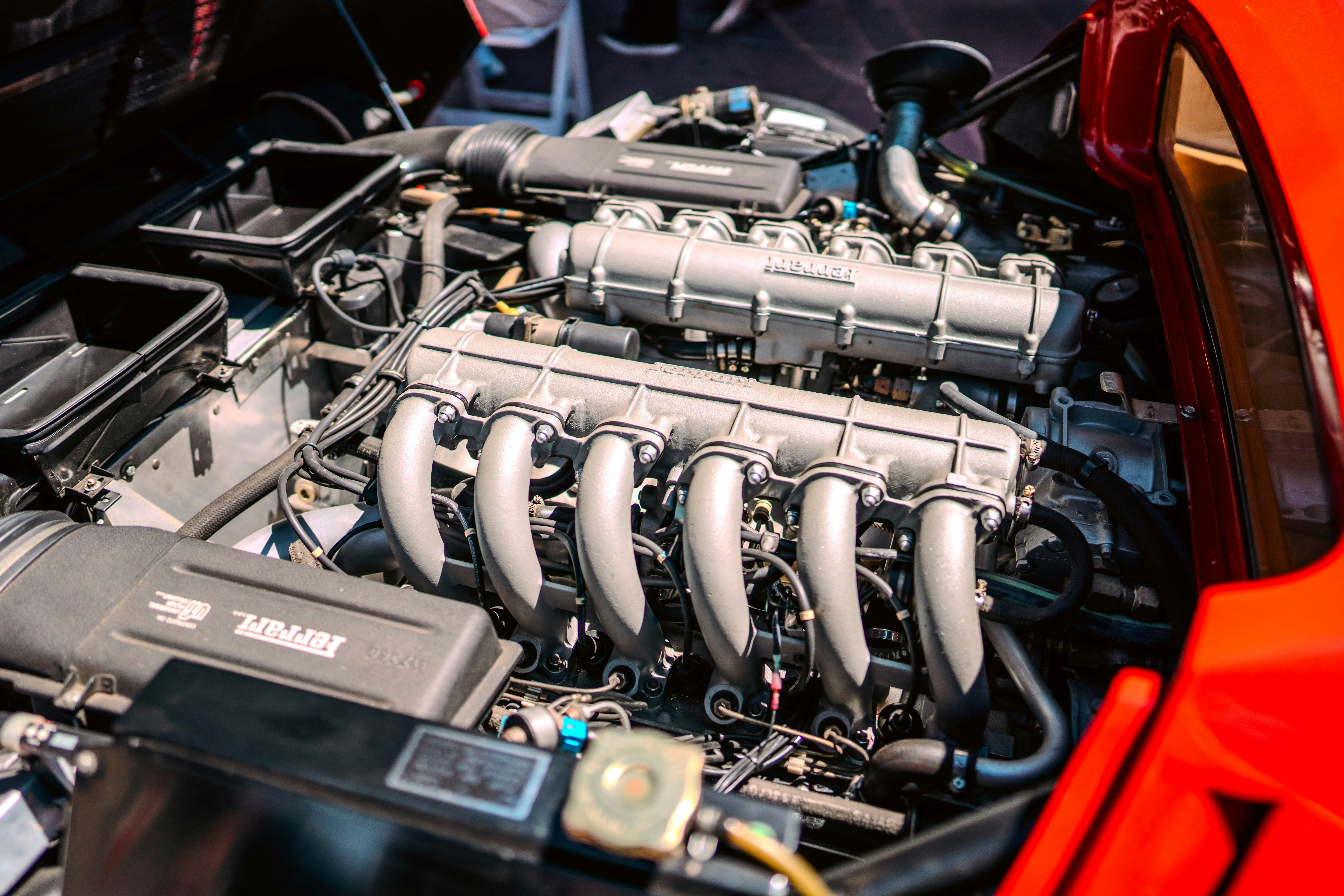 A close up of a car engine with its hood open photo – Free Engine Image ...