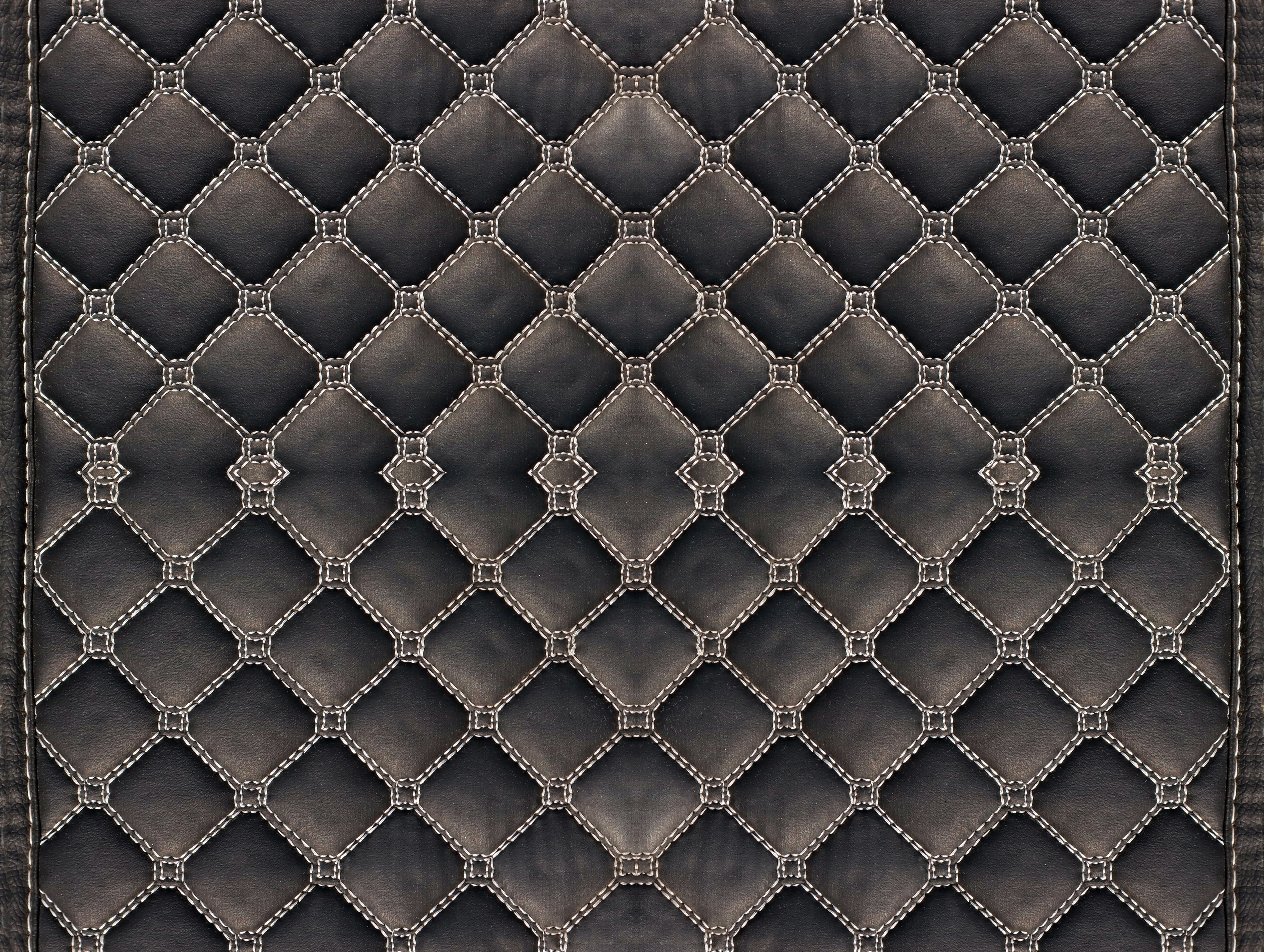 Diamond Stitchscape: a tactile close-up of quilted leather lattice