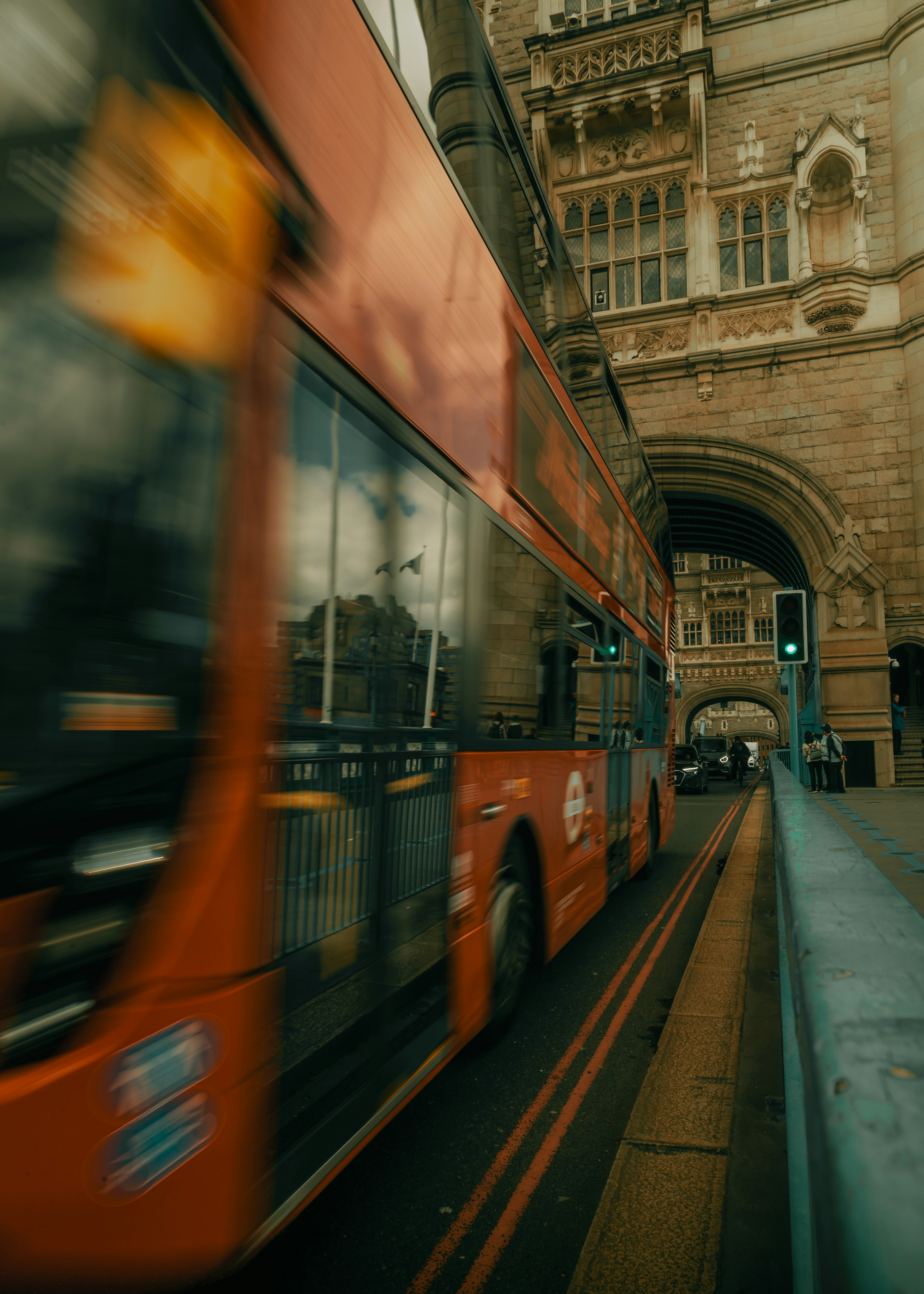 Tower Bridge in London | A red double decker bus driving down a street