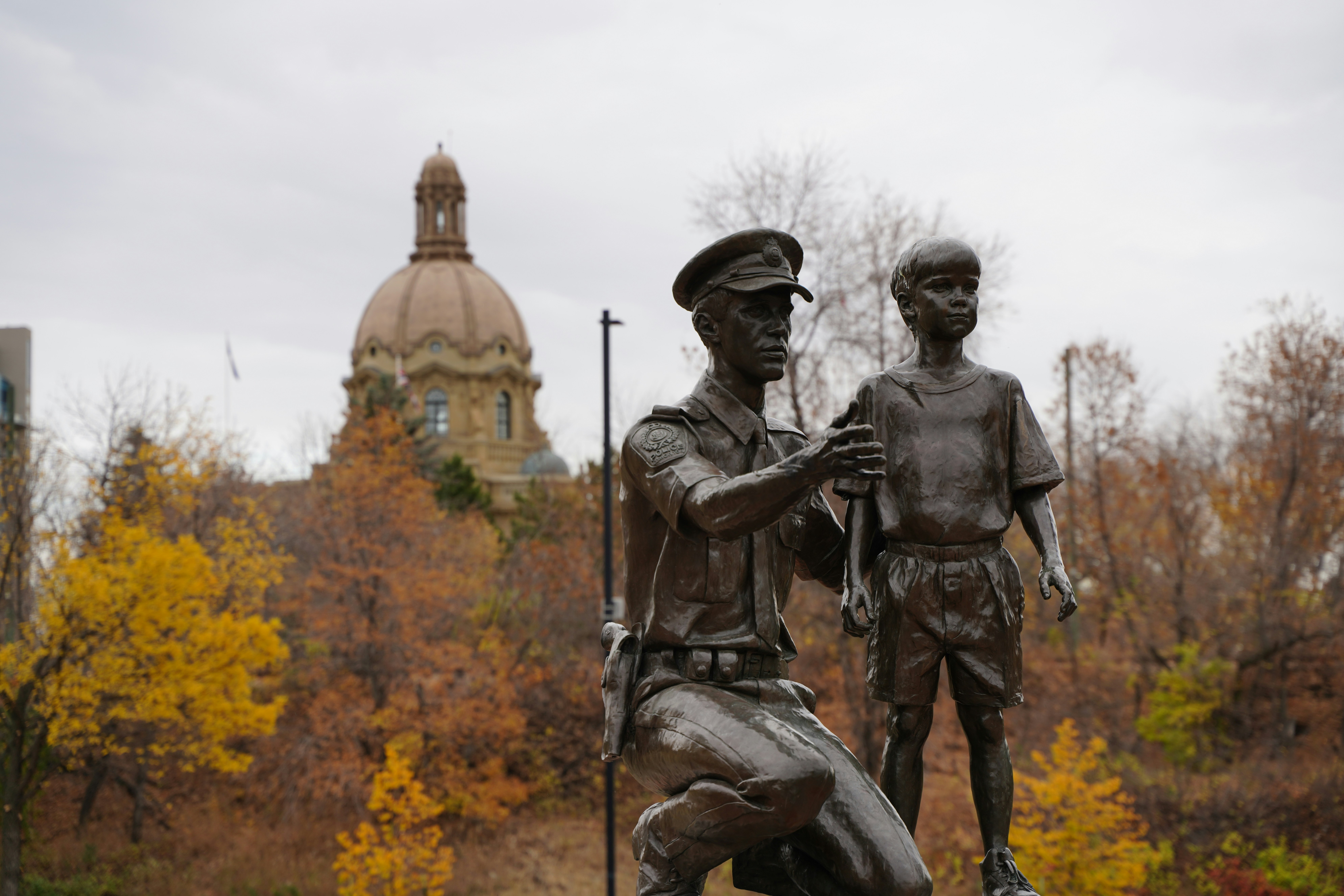 Autumn Sentinel: Bronze Soldier Guiding a Boy Before the City Dome