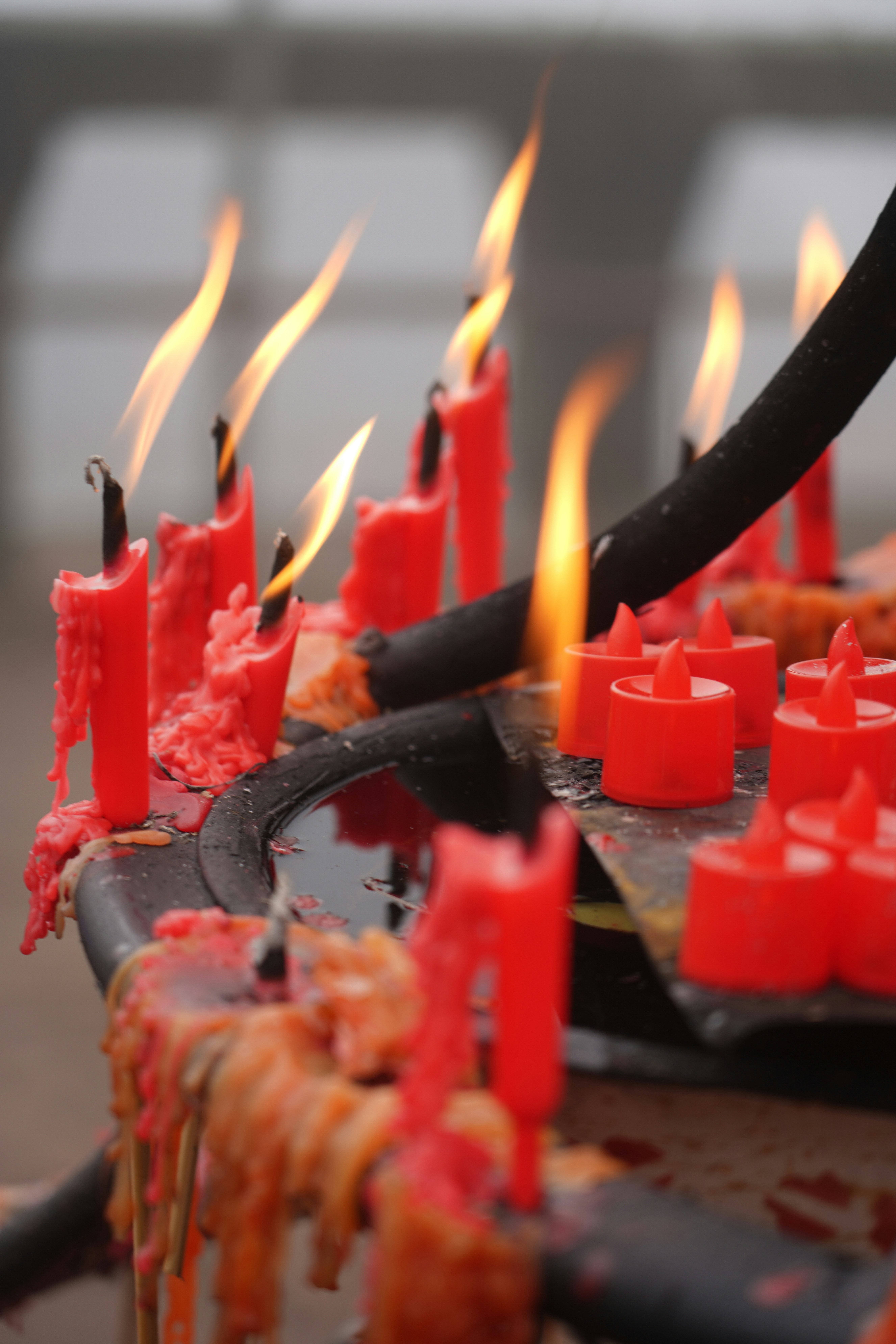Crimson Flames on a Melting Ring: A Close-Up Candle Scene