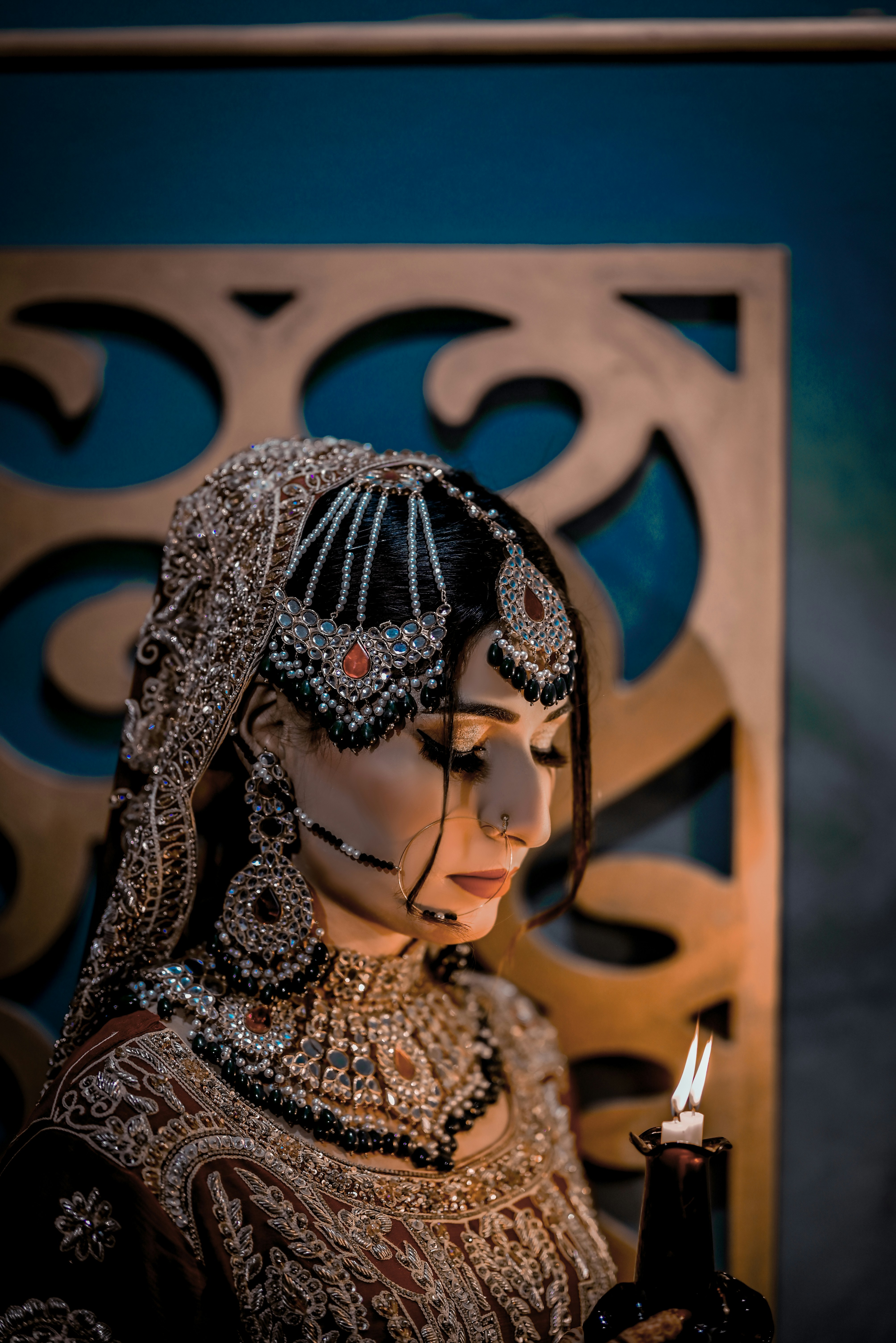 Gilded Veil Portrait: Bride Adorned in Crystalline Jewelry by a Soft Flame