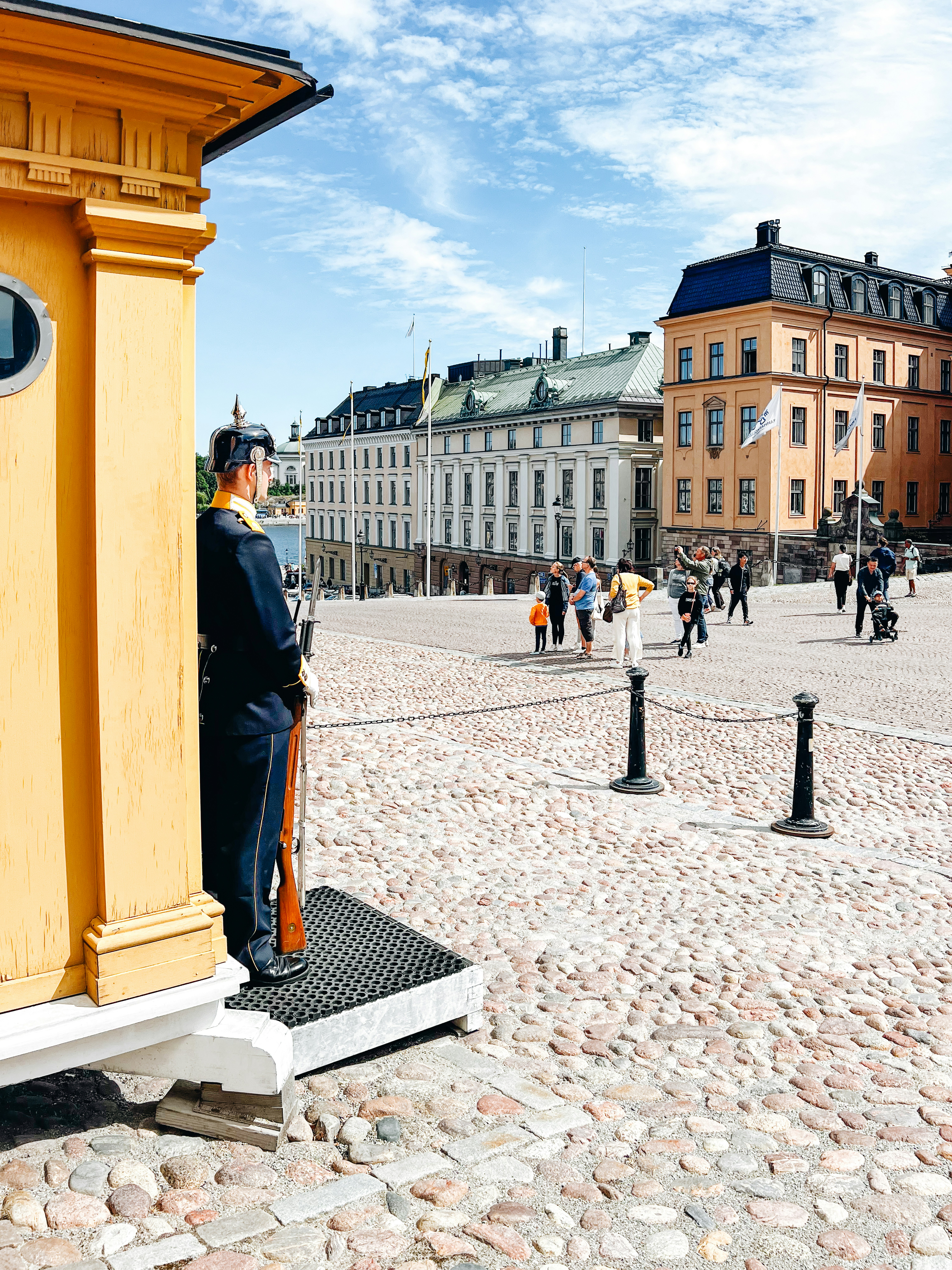 A man in uniform standing in front of a clock tower