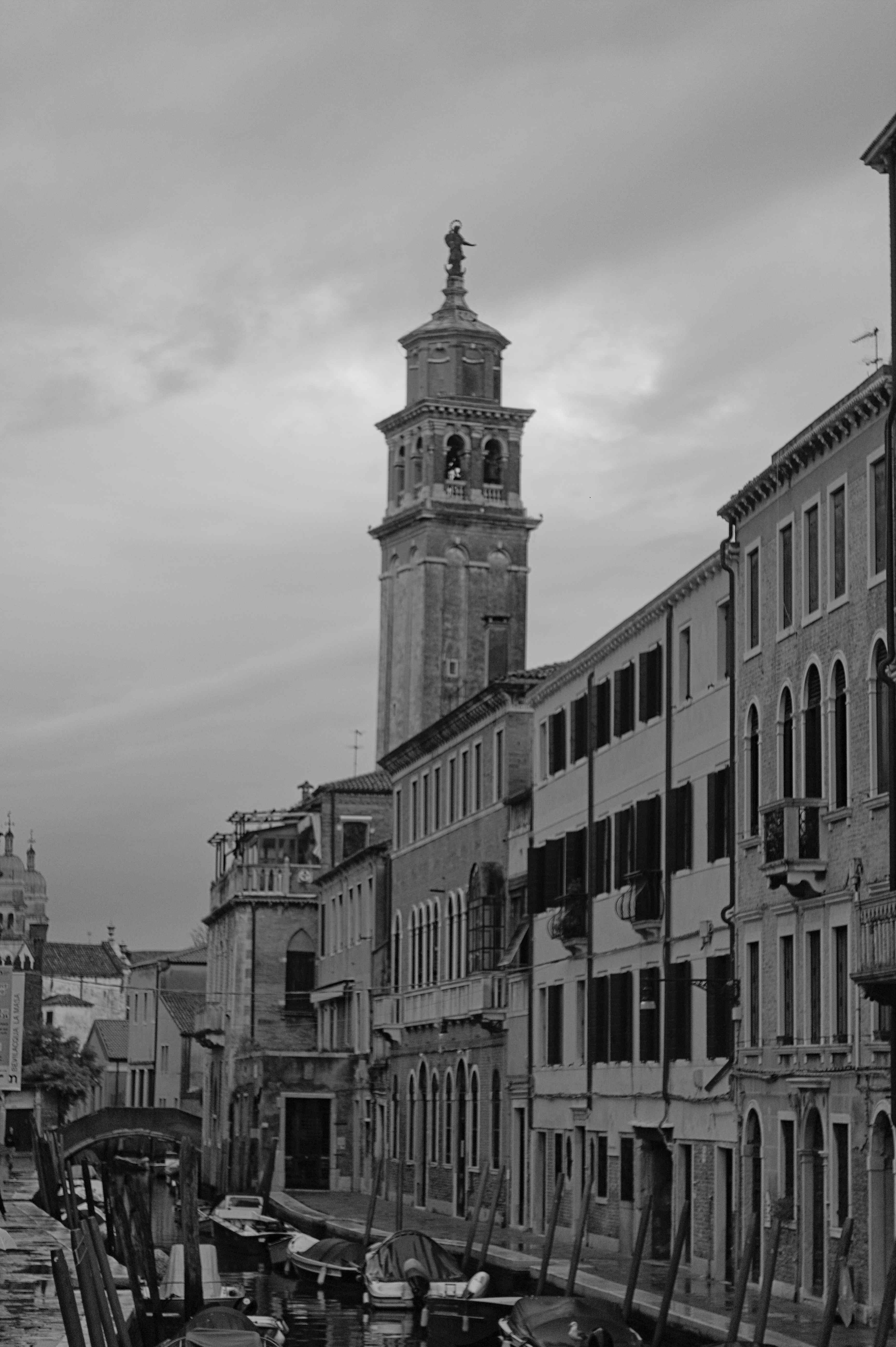 Bell Tower Over a Canal: A Monochrome Venice Street Scene