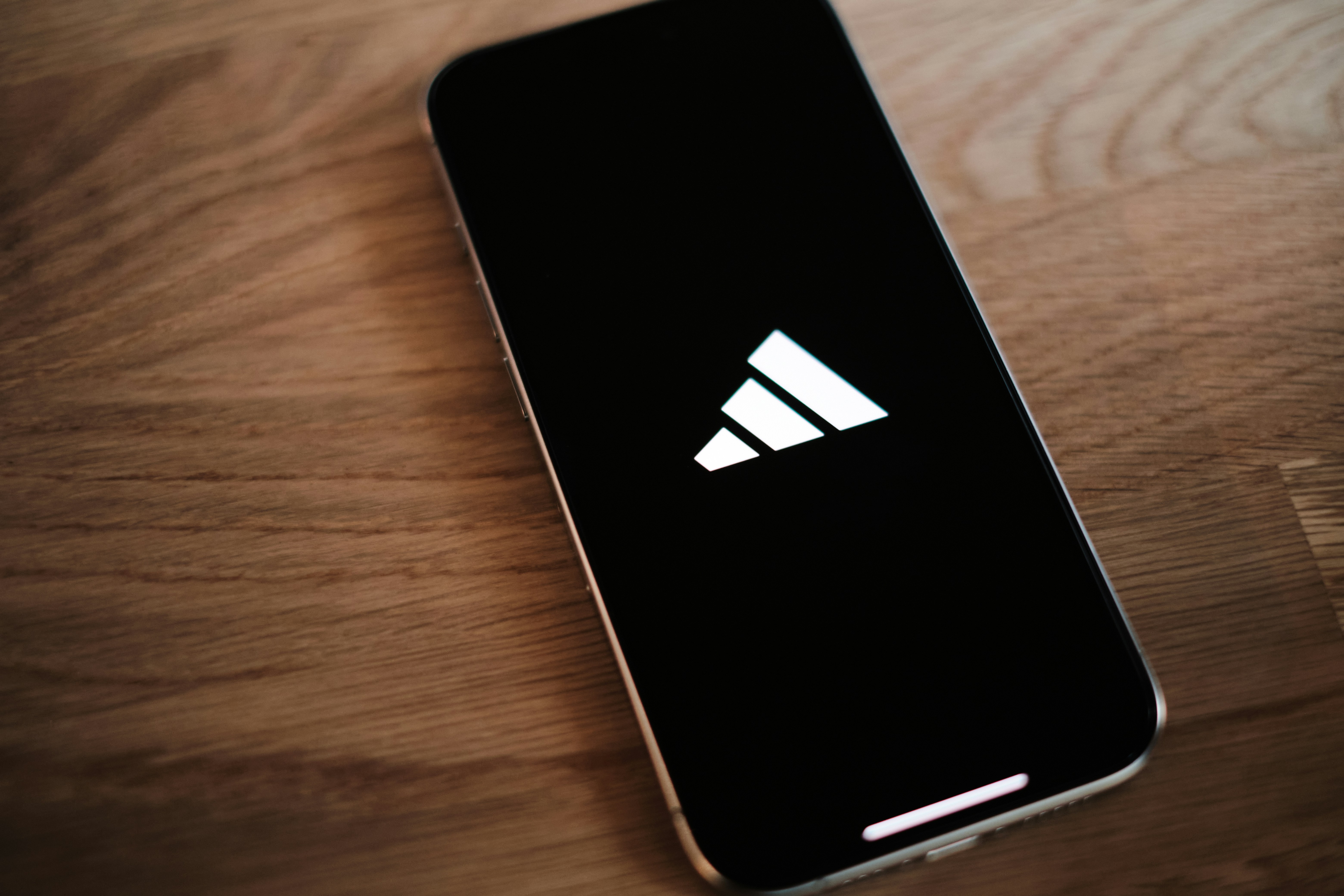 Logo Glow: A Close-Up of a Triangular Icon on a Slanted Phone Screen