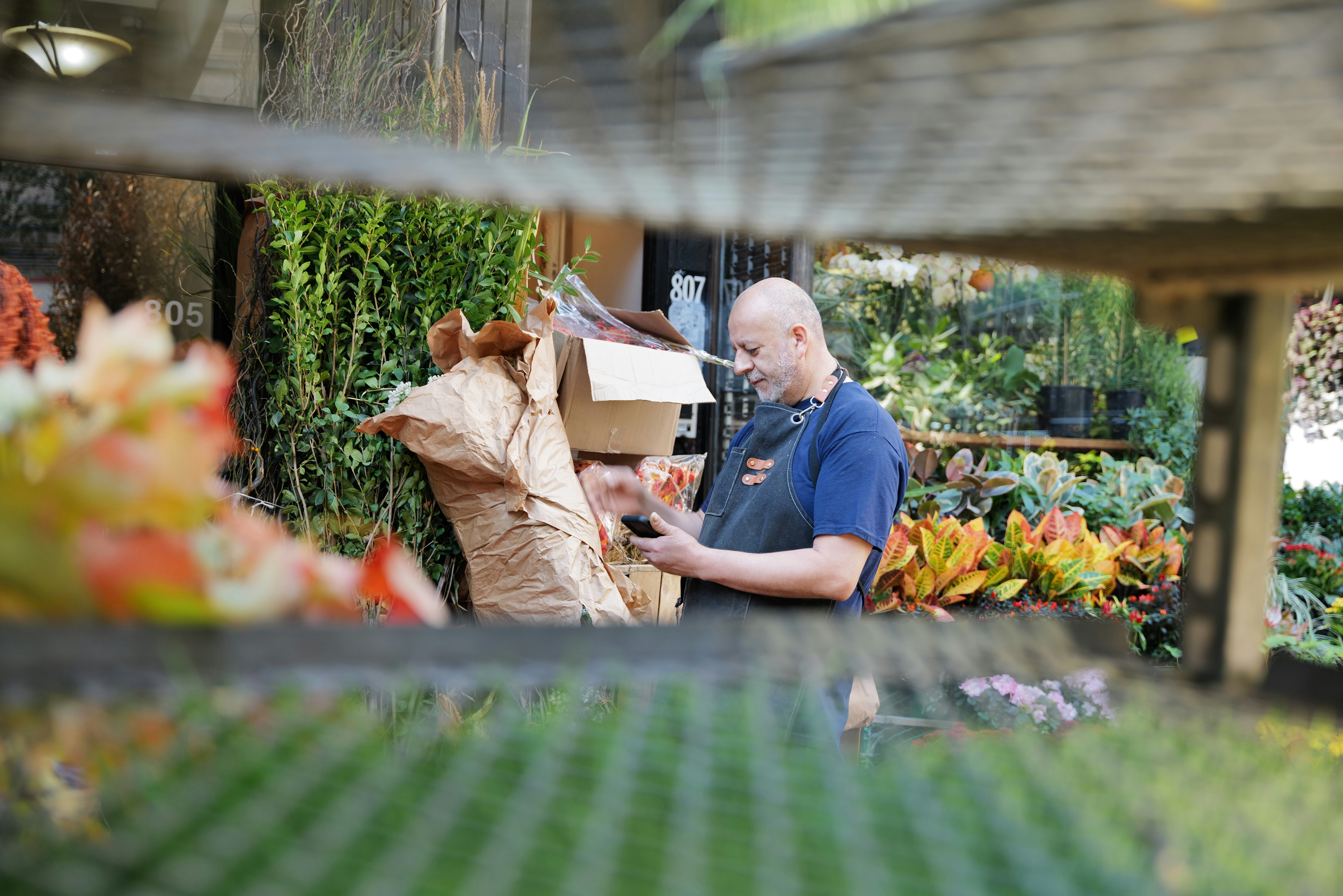 Unpacking Care at the Garden Center: A Quiet Moment Among Colorful Pots