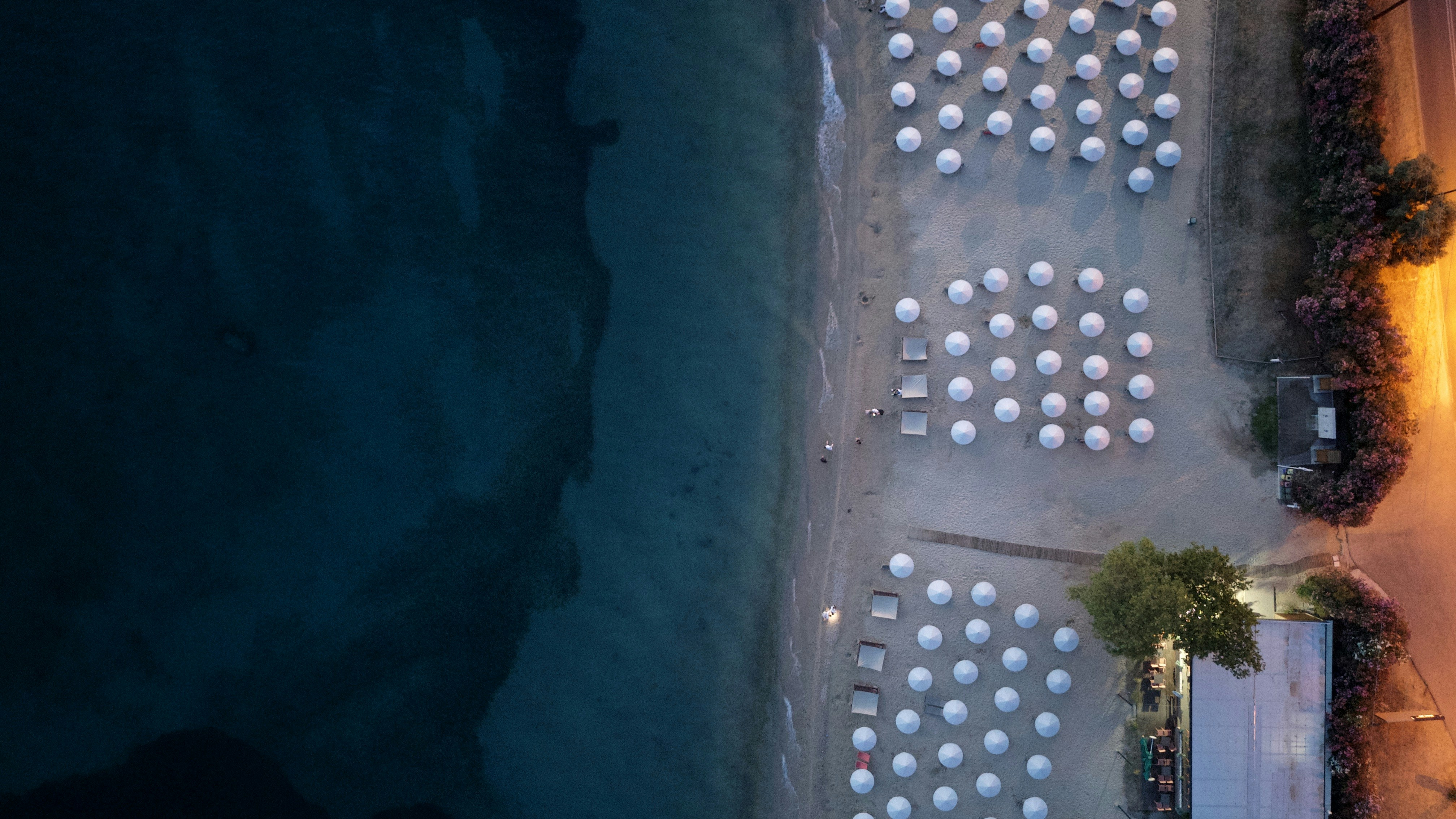Coastal Grid: Aerial Mosaic of Beach Umbrellas