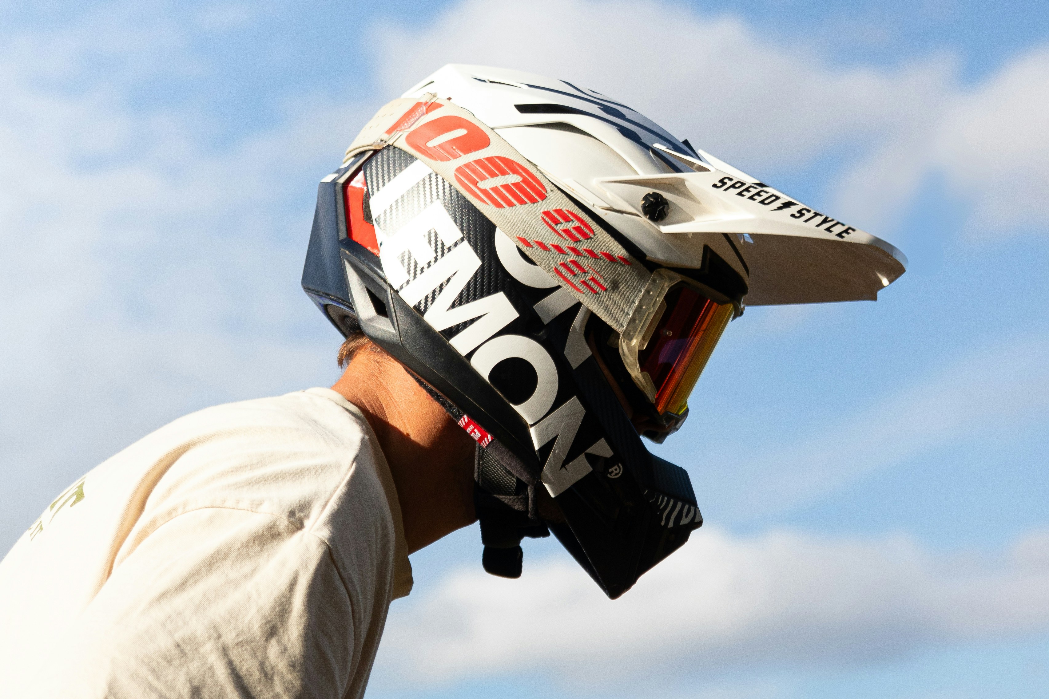 Profile in Motion: a helmeted rider against a cerulean sky