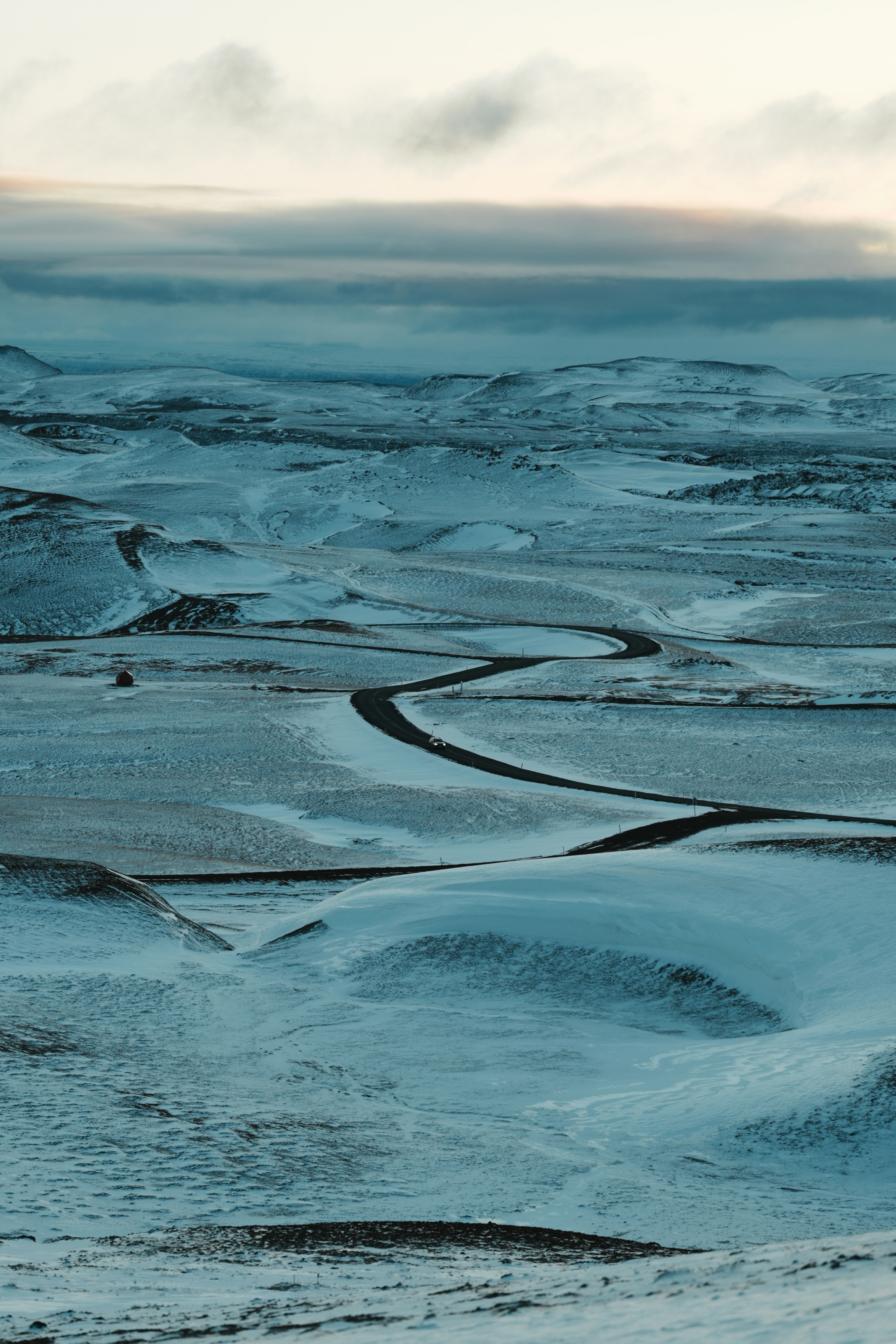 A snow covered landscape with a winding road photo – Free Land Image on ...