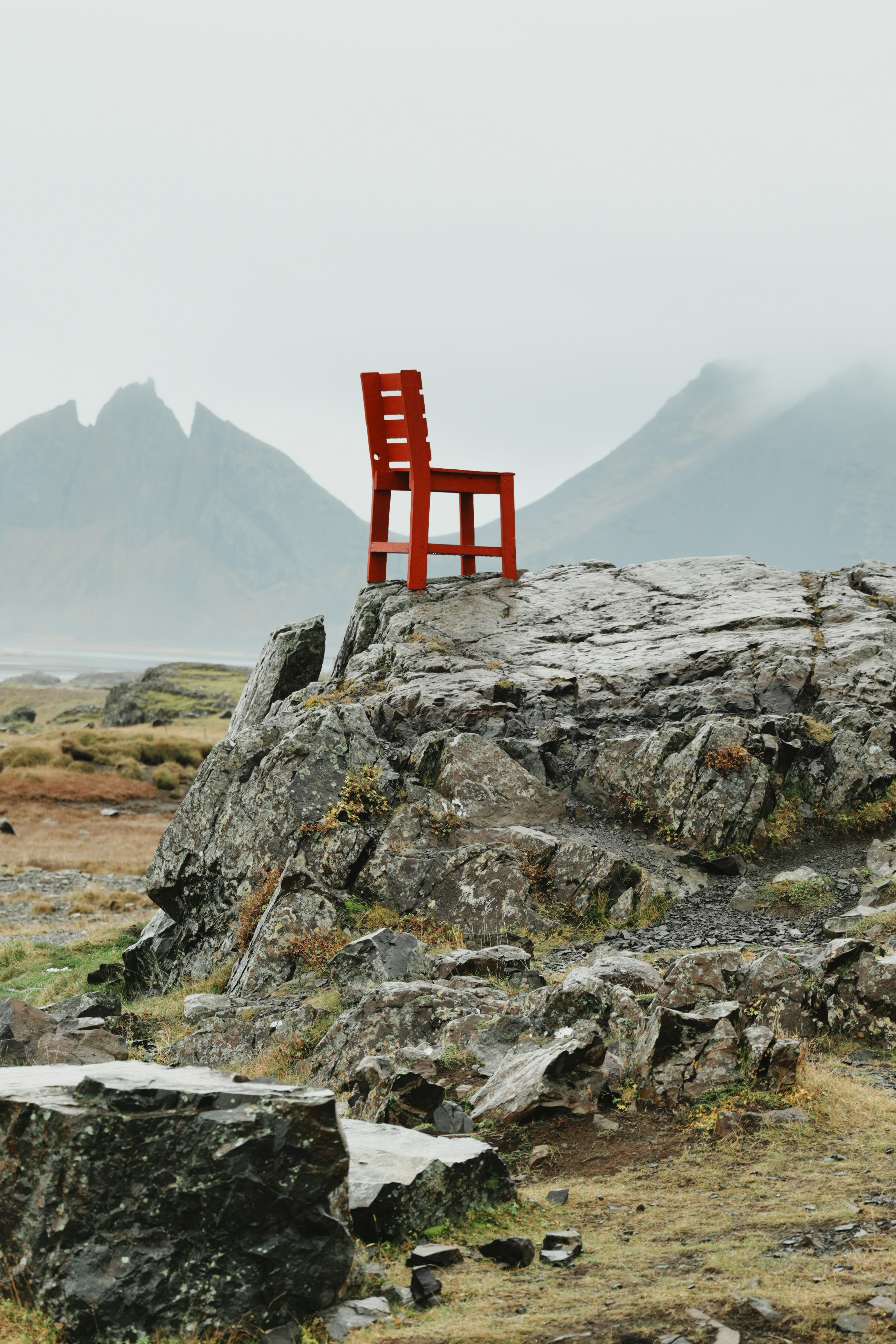 A red chair sitting on top of a large rock photo – Free Iceland Image ...