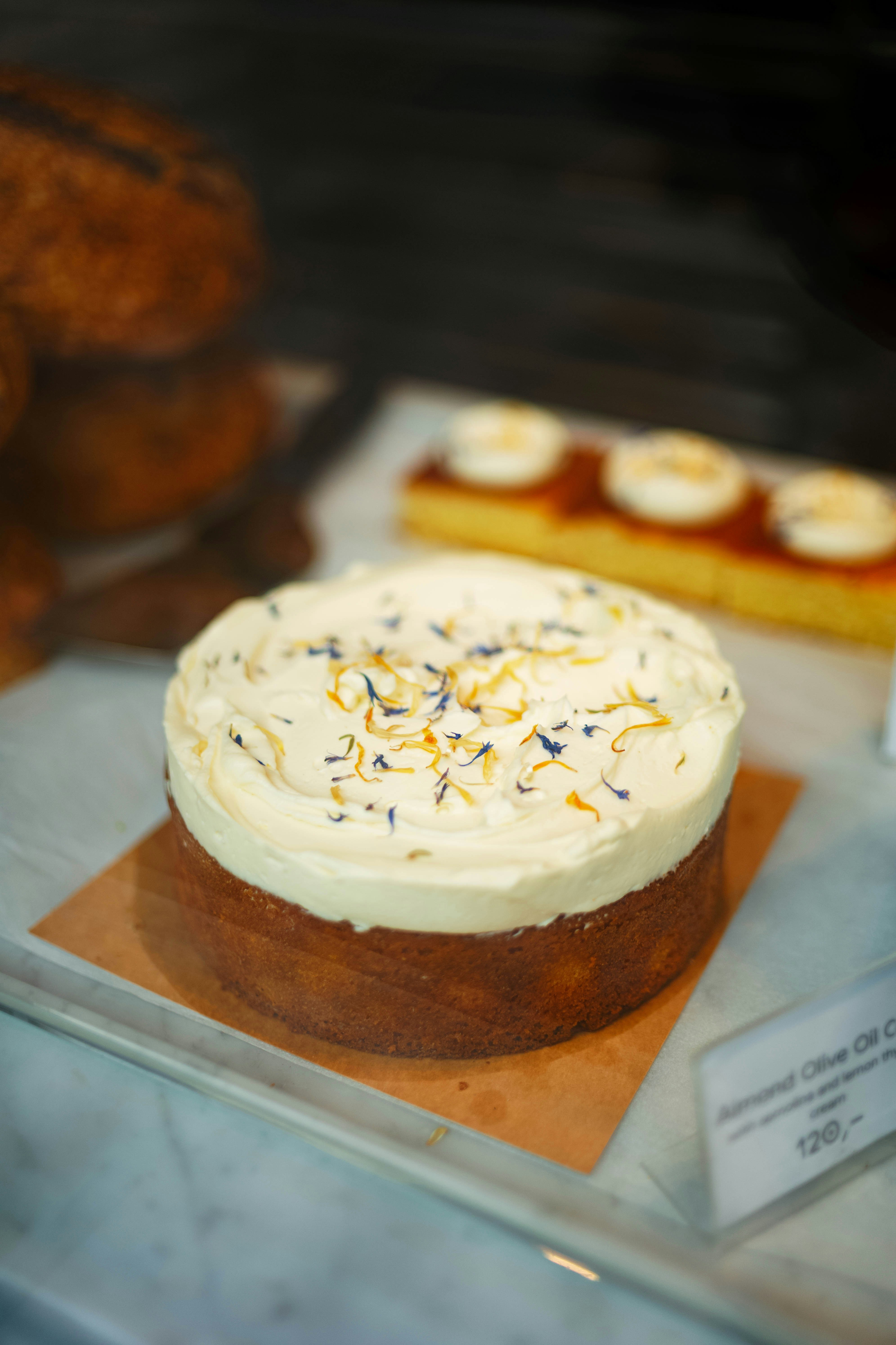 A close up of a cake in a display case photo – Free Dessert Image on ...
