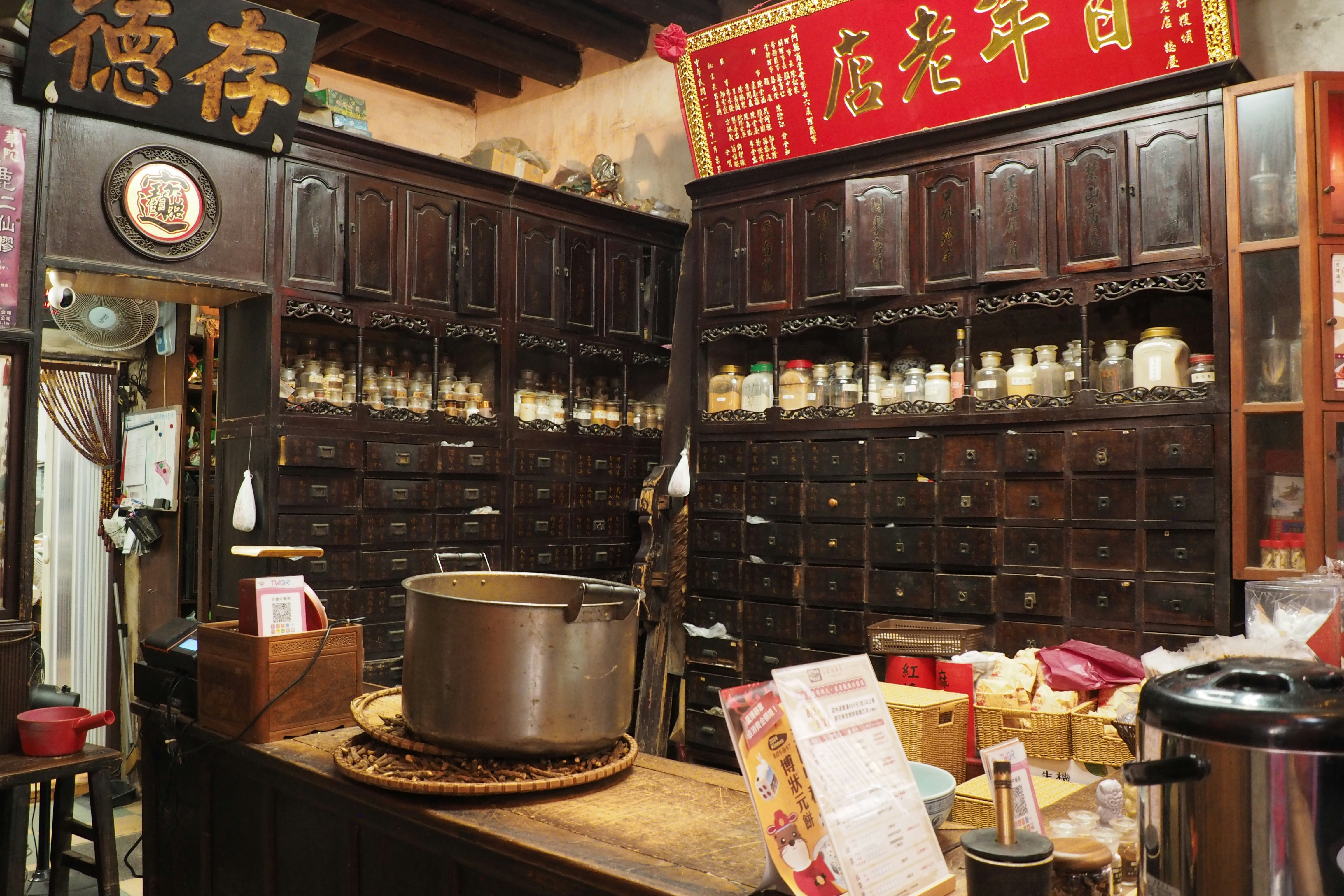 A room filled with lots of wooden shelves filled with pots and pans ...
